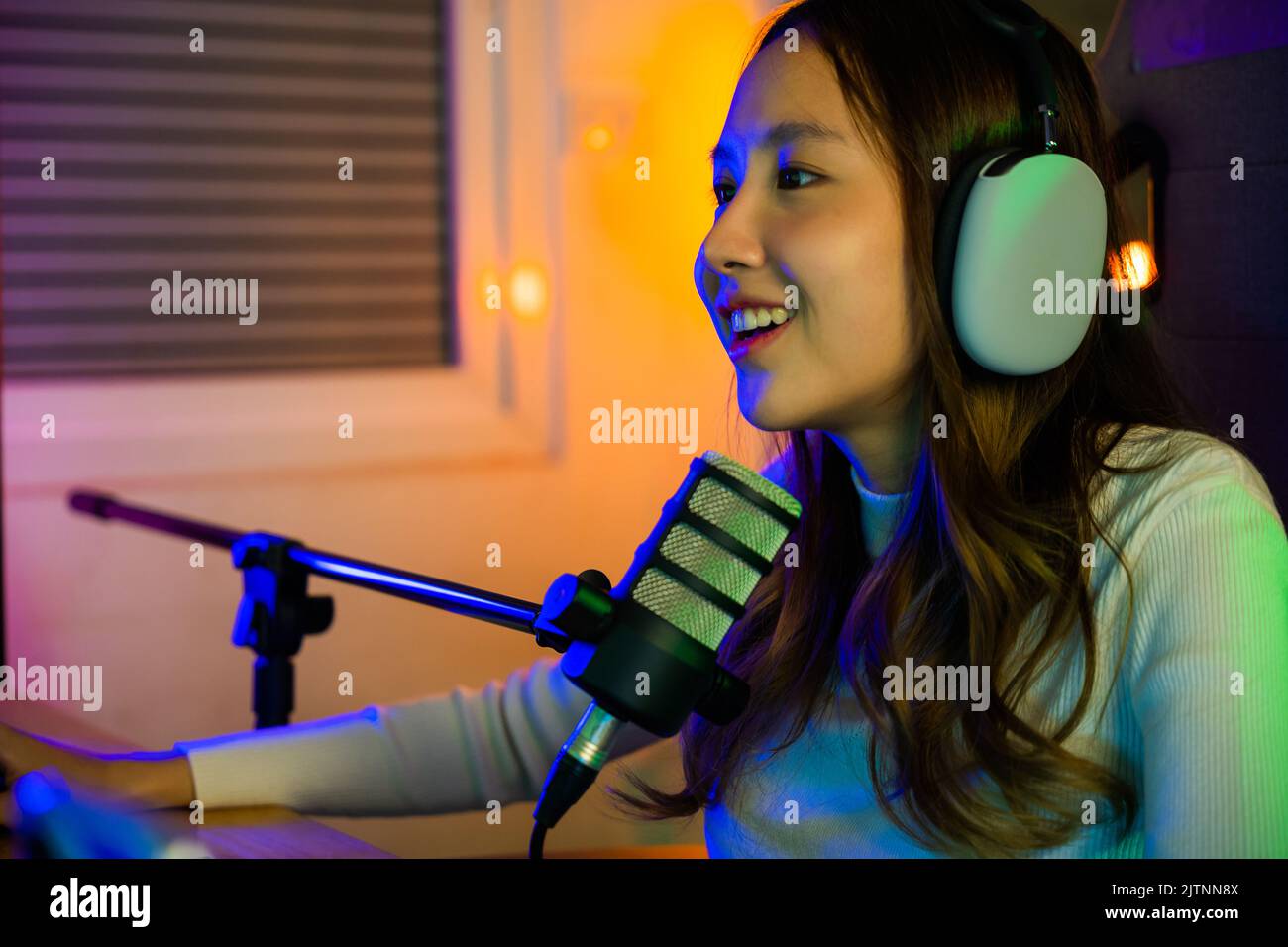 Asian young gamer woman playing video games online on computer she live ...