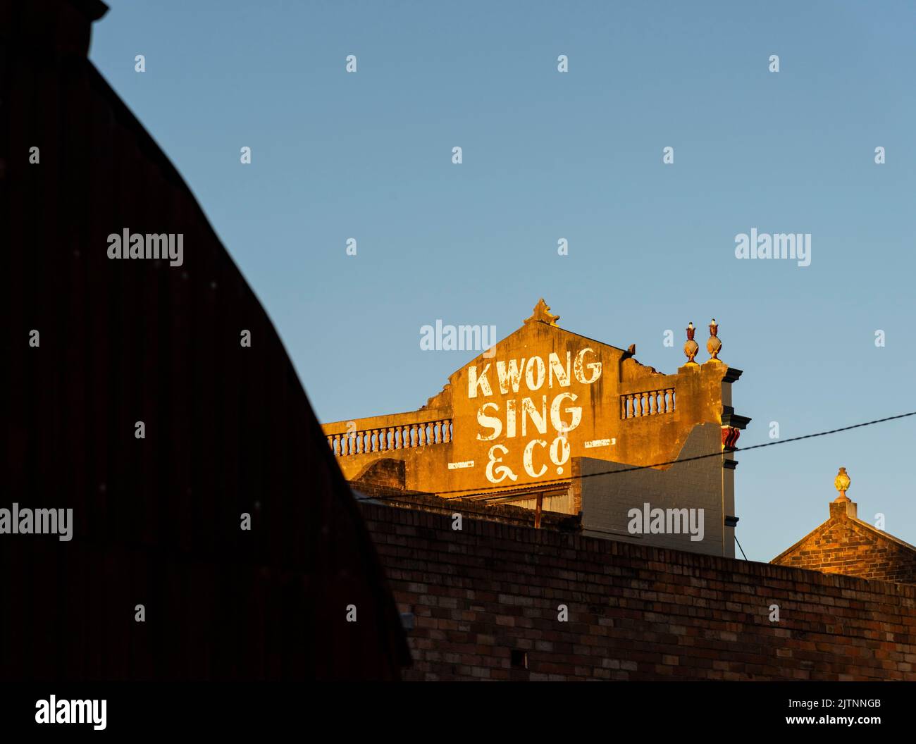 The setting sun lights up the back of the old Kwong Sing and Co facade ...