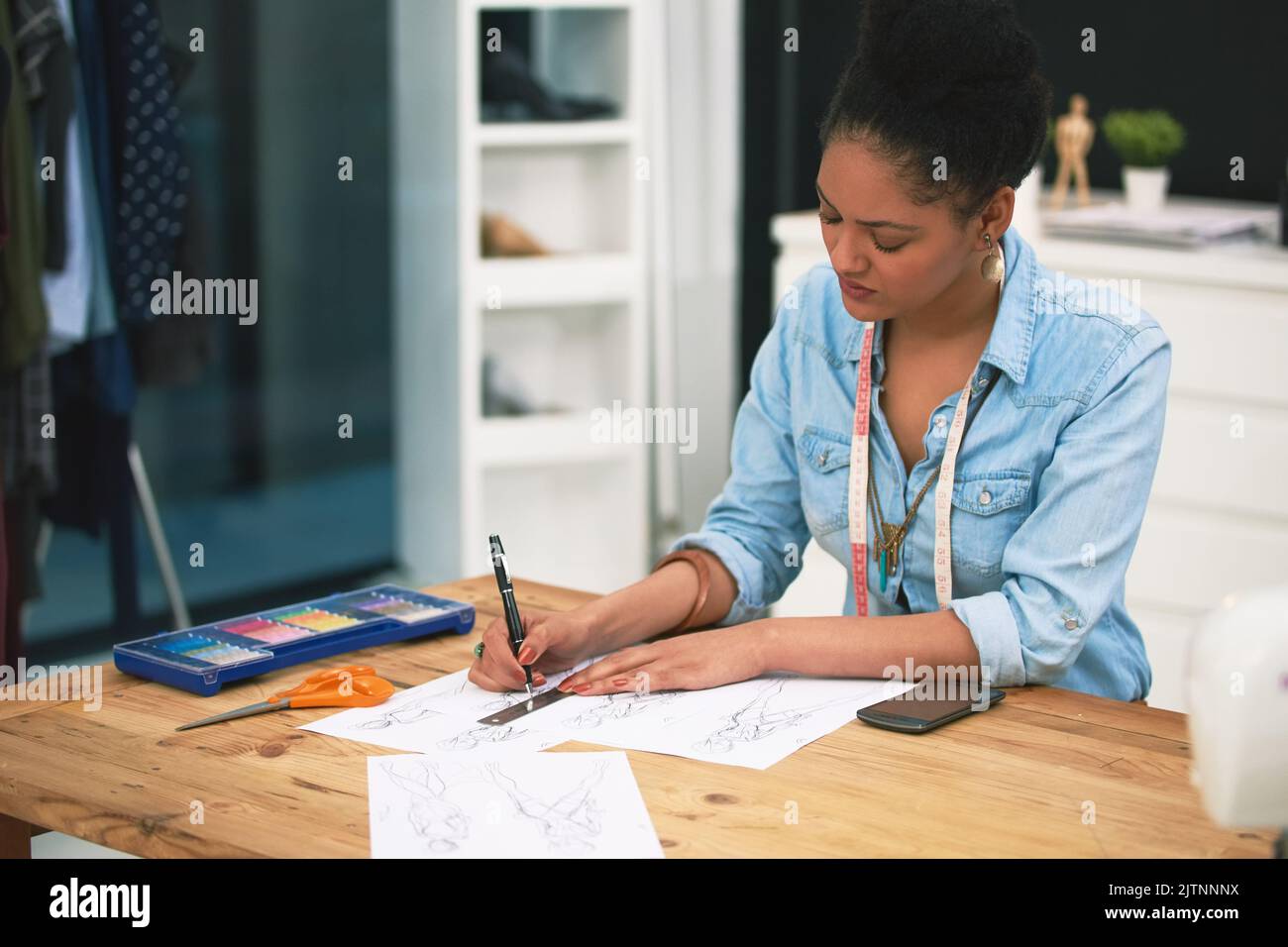Her designs are perfect. an attractive young designer sketching a new ...