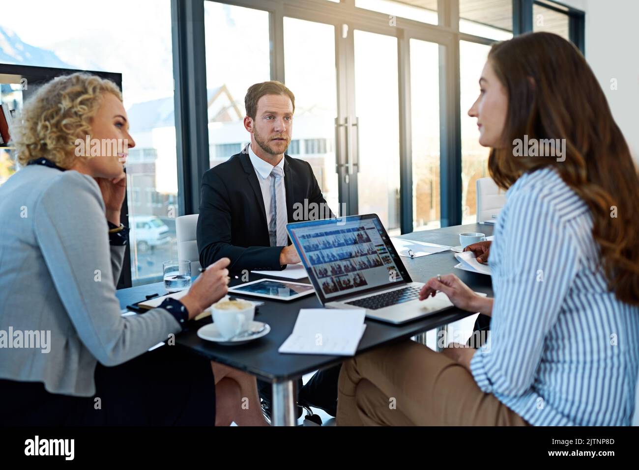 Bouncing some ideas around. three corporate businesspeople working in ...