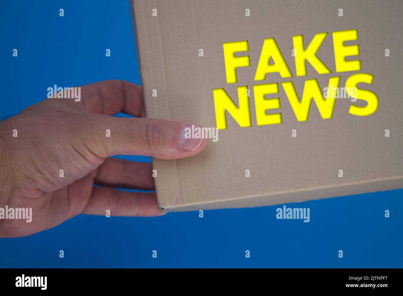 Fake News word with cardboard box. Brown folded cardbox Stock Photo - Alamy