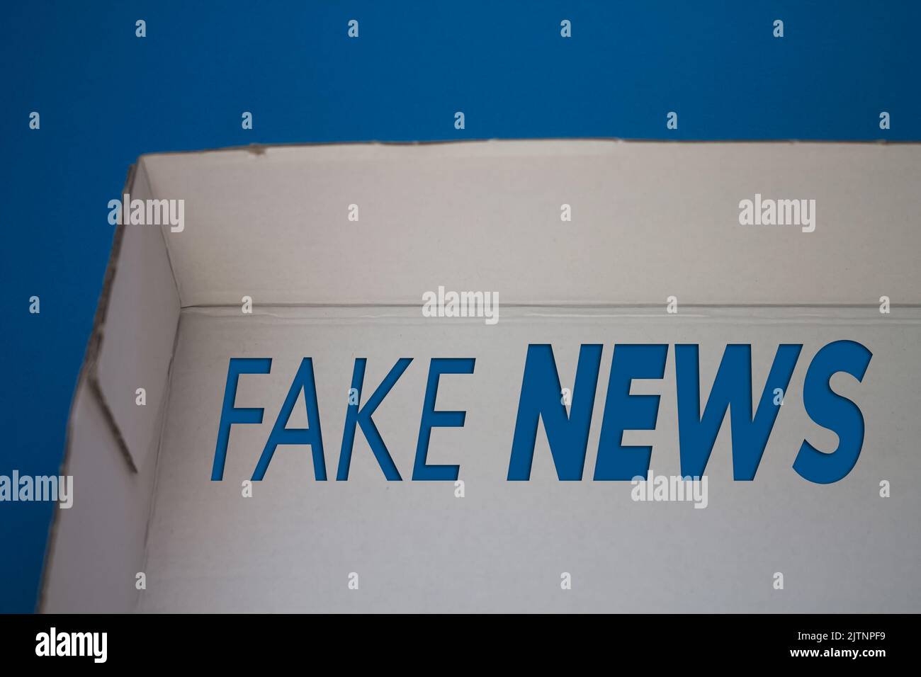 Fake News word with cardboard box. Brown folded cardbox Stock Photo - Alamy