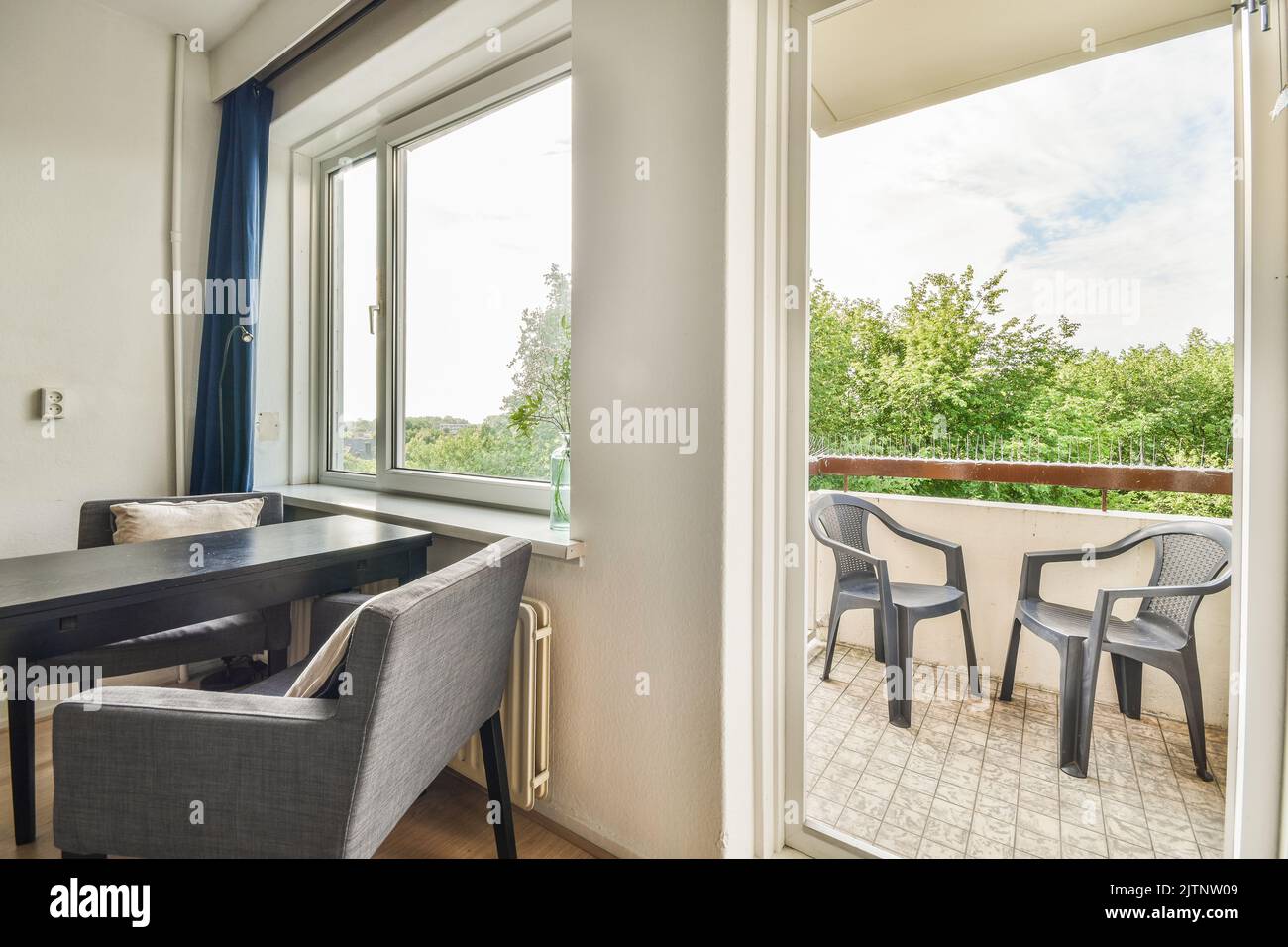 Interior of light room with stylish dining and lounge areas in modern ...