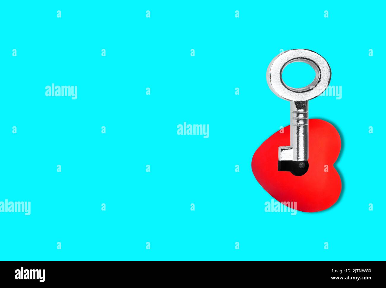 Heart with a keyhole and a skeleton key isolated on blue background ...