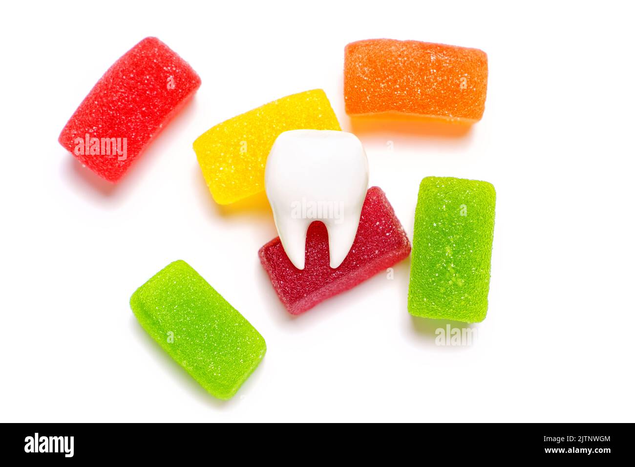 Large white tooth model and a bunch of colorful jelly candies isolated ...