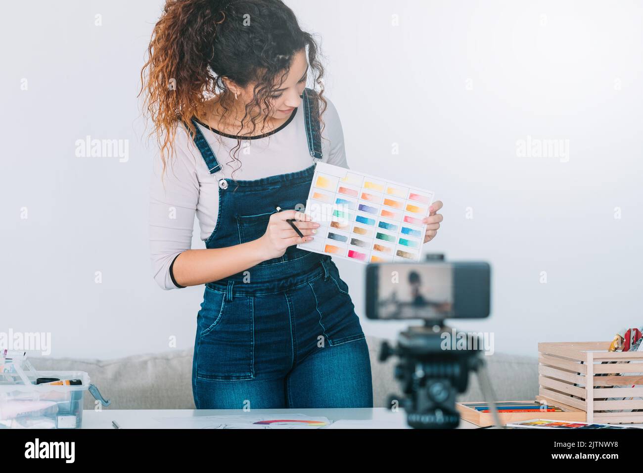 online art course lady camera paint color swatch Stock Photo - Alamy