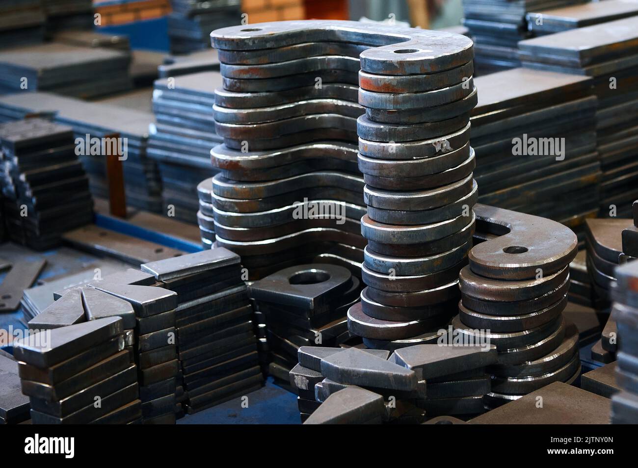 Piles of different workpieces made of metal material sheet Stock Photo ...
