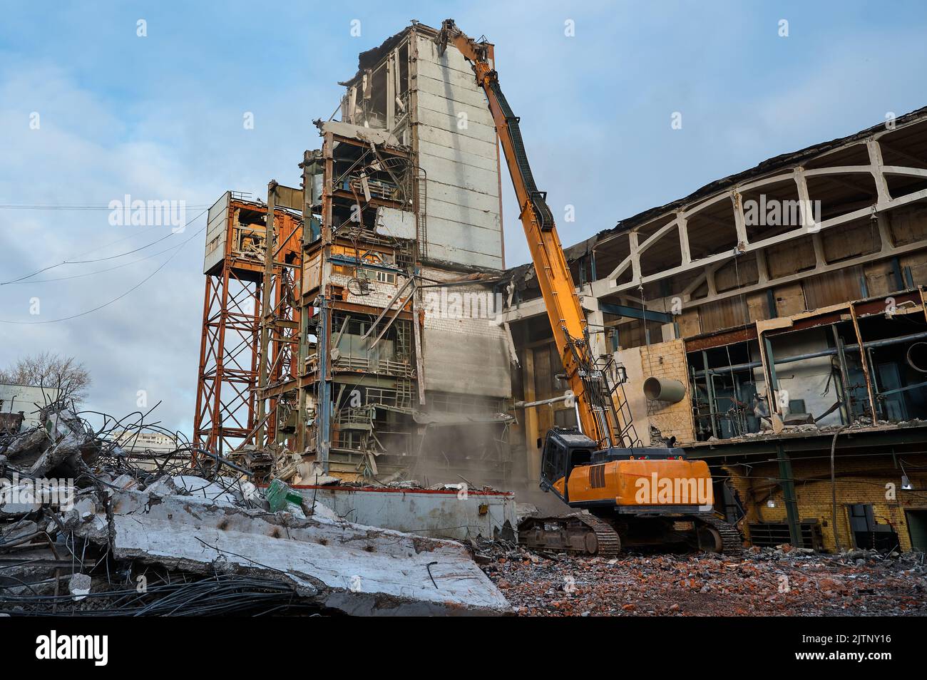 Destroying of old industrial building by excavator destroyer Stock ...