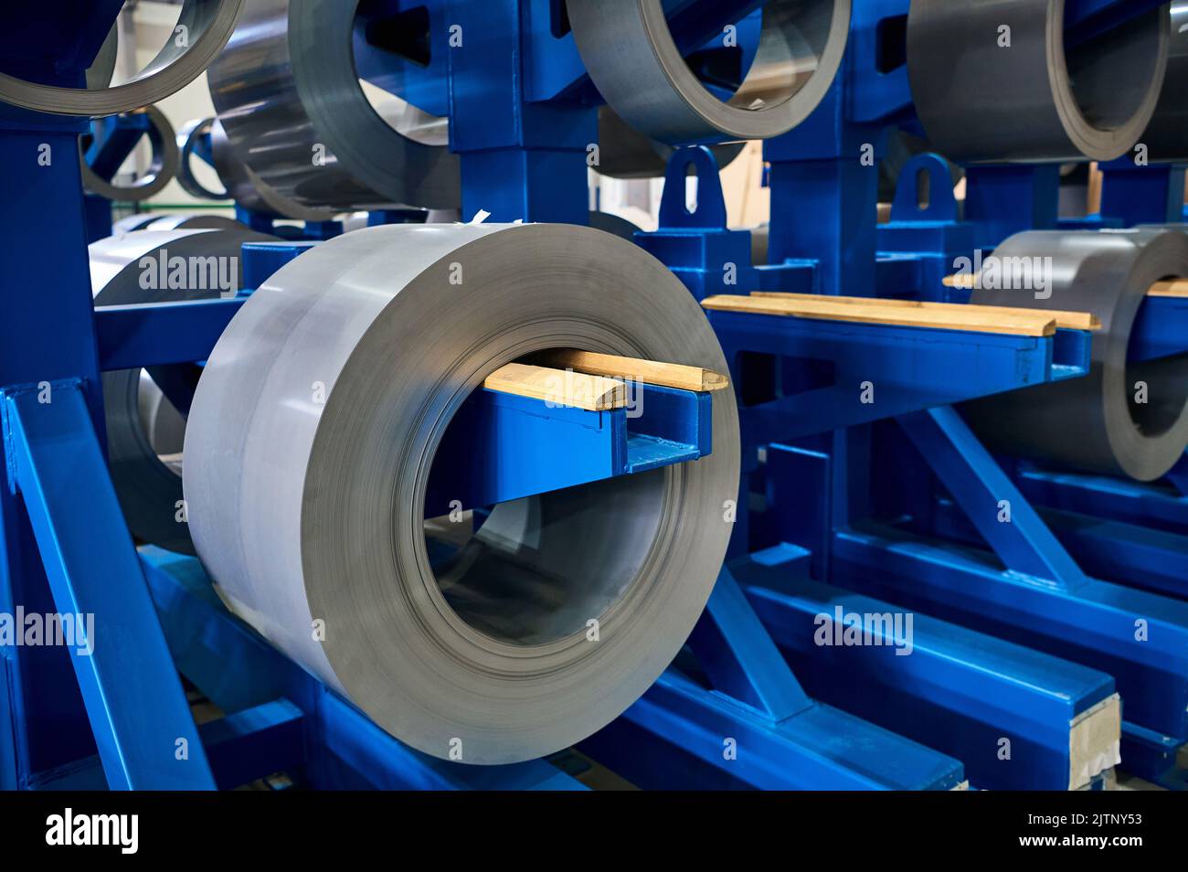 Large rolls of electrical transformer steel hang on rack Stock Photo ...