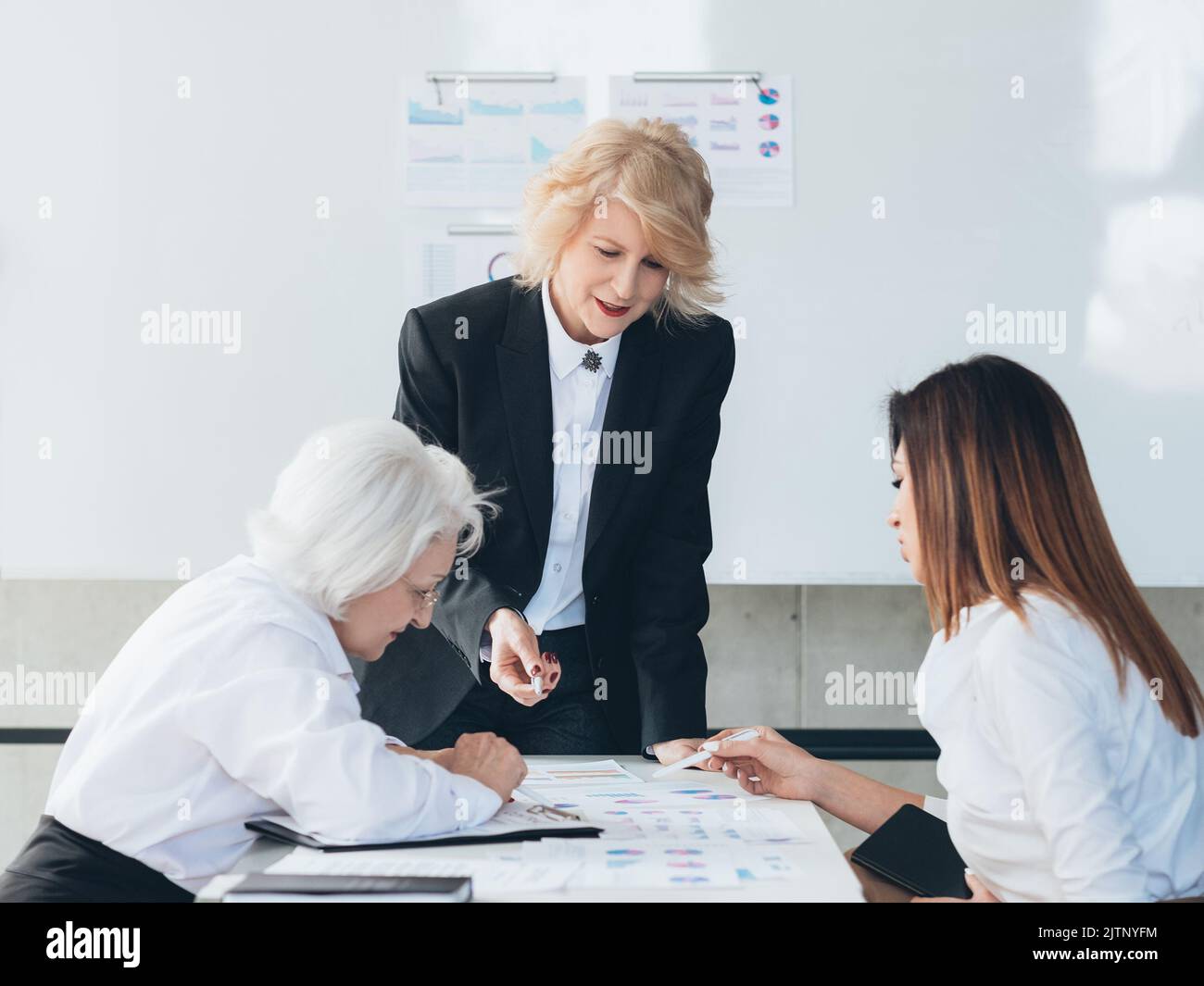 team meeting business women infographics analysis Stock Photo - Alamy