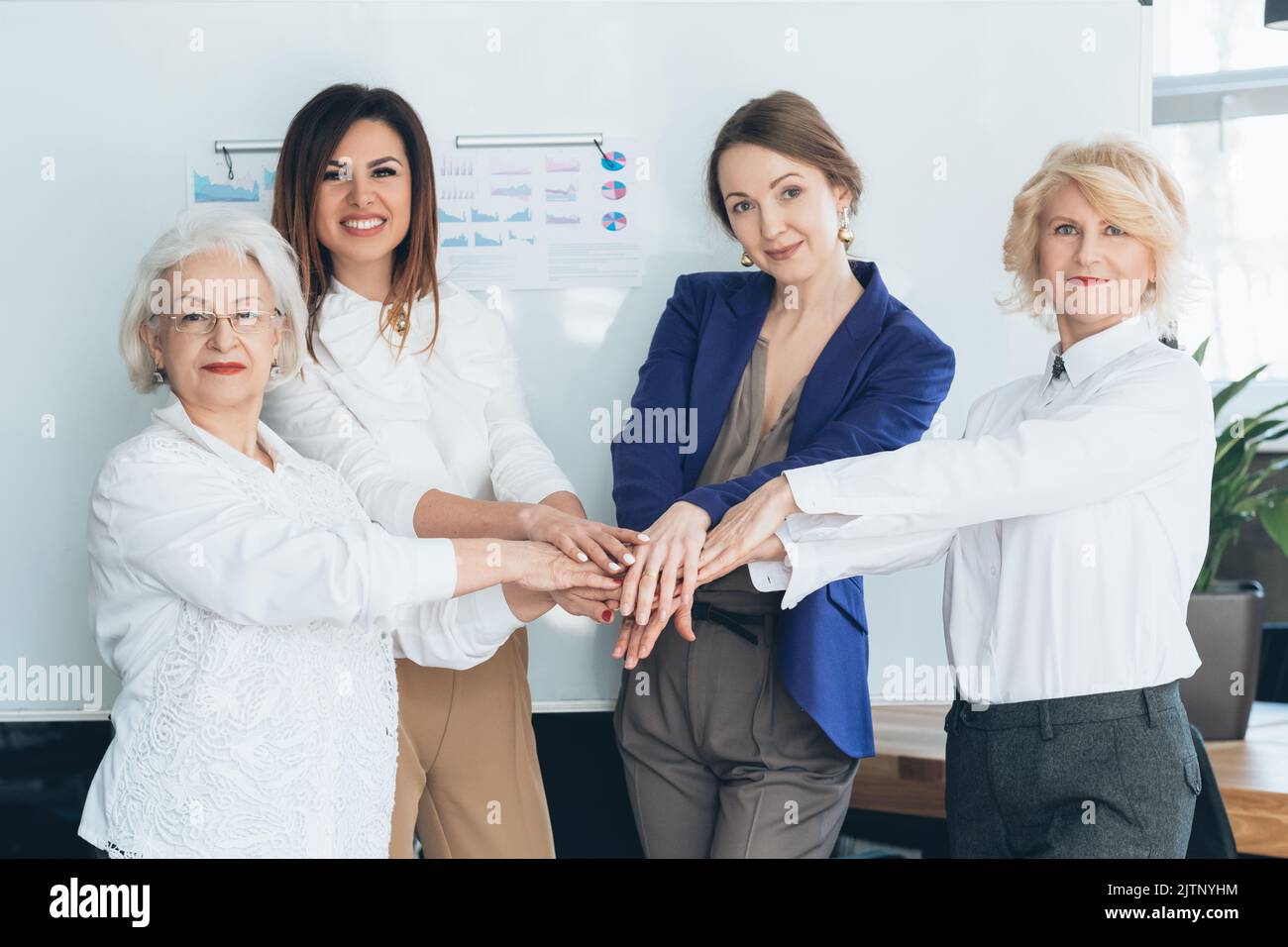 business women hands together teamwork diversity Stock Photo - Alamy