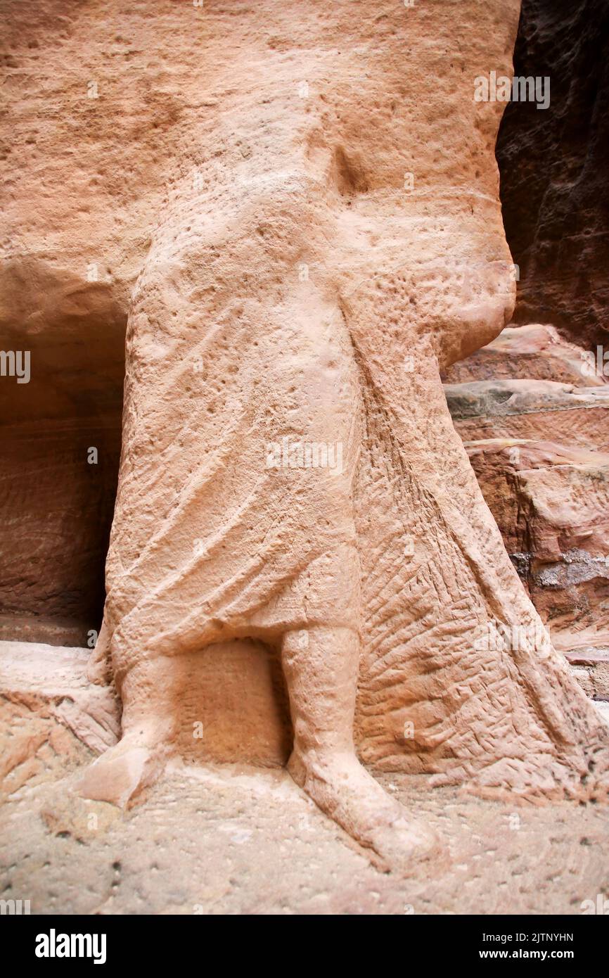 Destroyed figure with feet in the sig gorge to Petra Stock Photo - Alamy