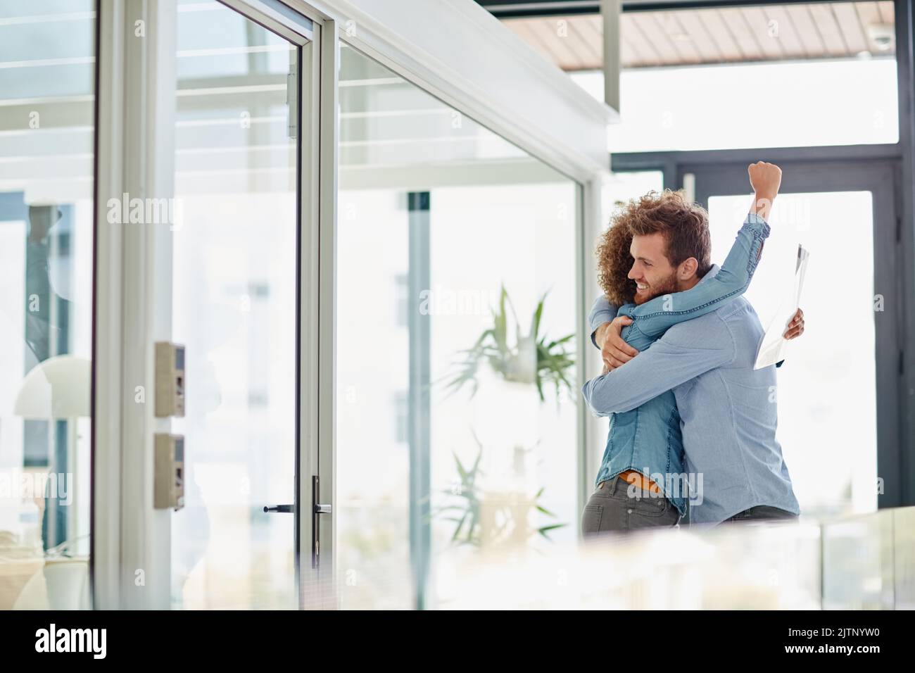 Theyre so proud of what theyve achieved. two colleagues hugging each ...