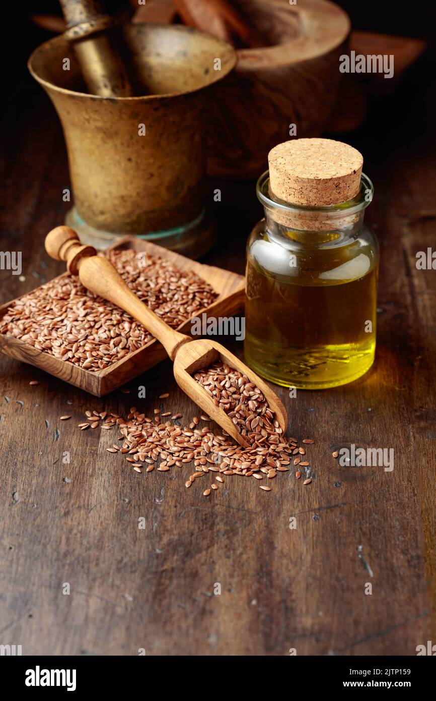 Flaxseeds and linseed oil. Linseed oil with kitchen utensils on an old ...