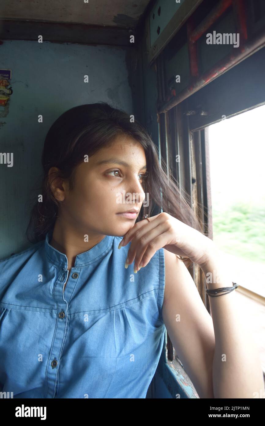 A young women traveling in train in India Stock Photo - Alamy