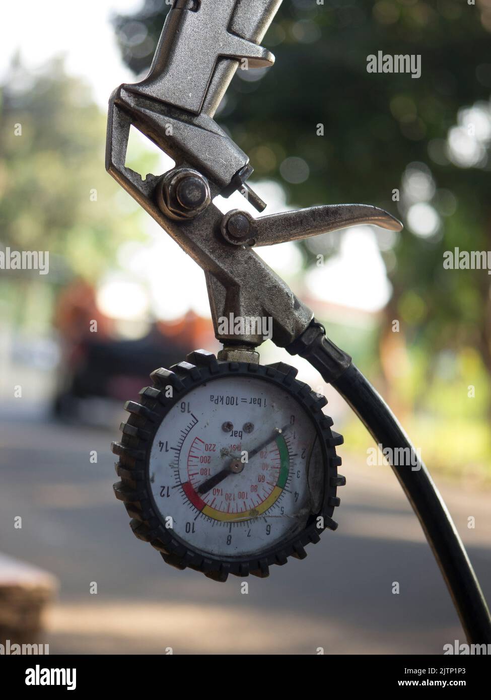 Hand pneumatic tire inflator gun with the pressure gauge on Blurry ...