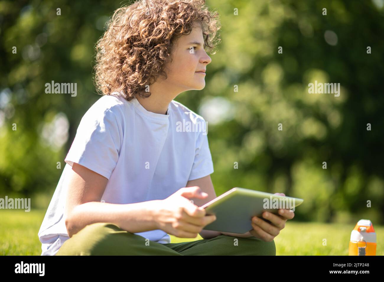 Teen with the gadget spending time in nature Stock Photo - Alamy