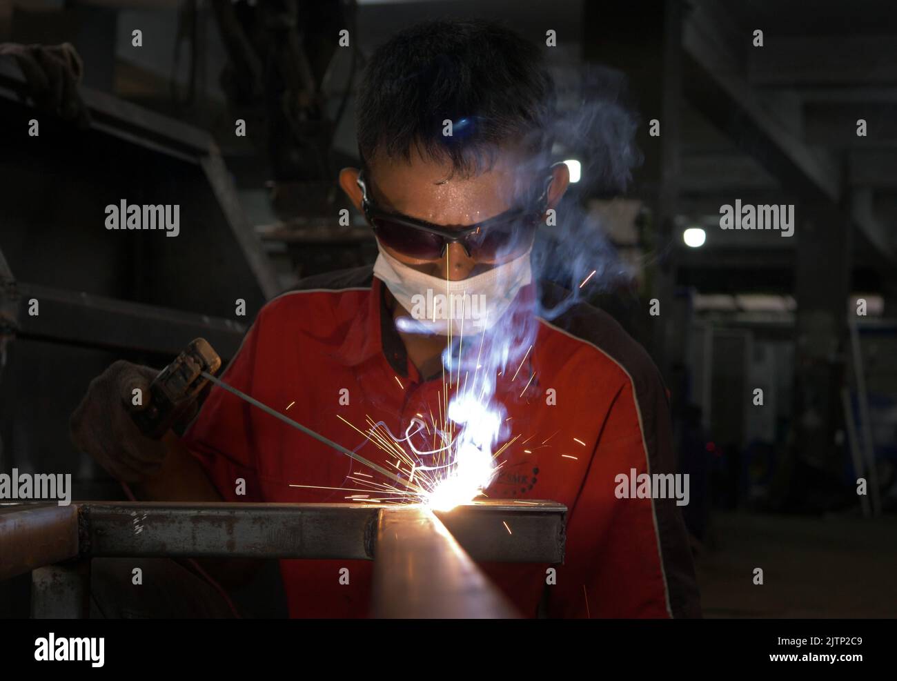 Worker welding iron Stock Photo - Alamy