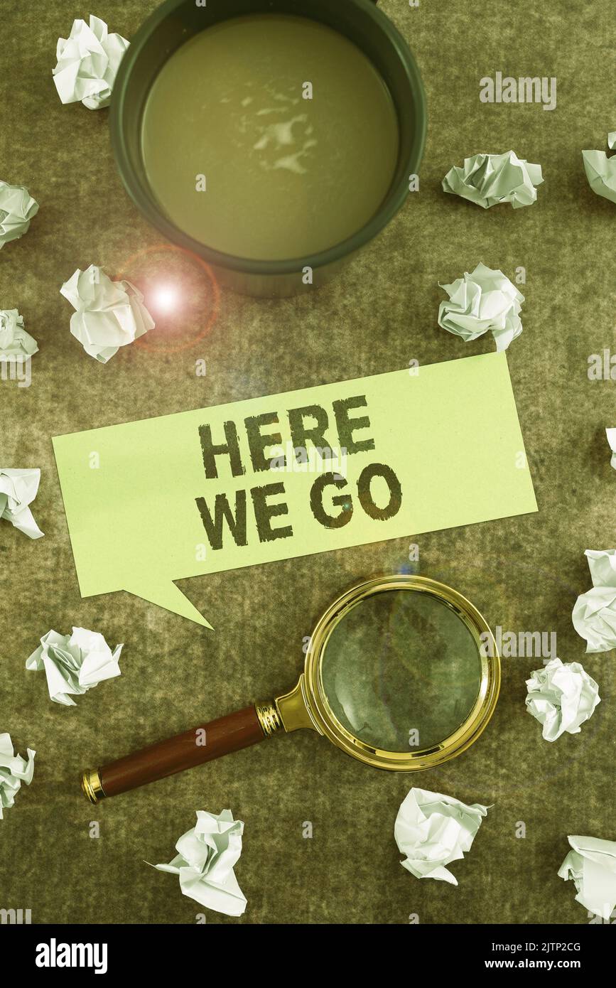 Hand writing sign Here We Go, Word for Be on the way of doing something ...