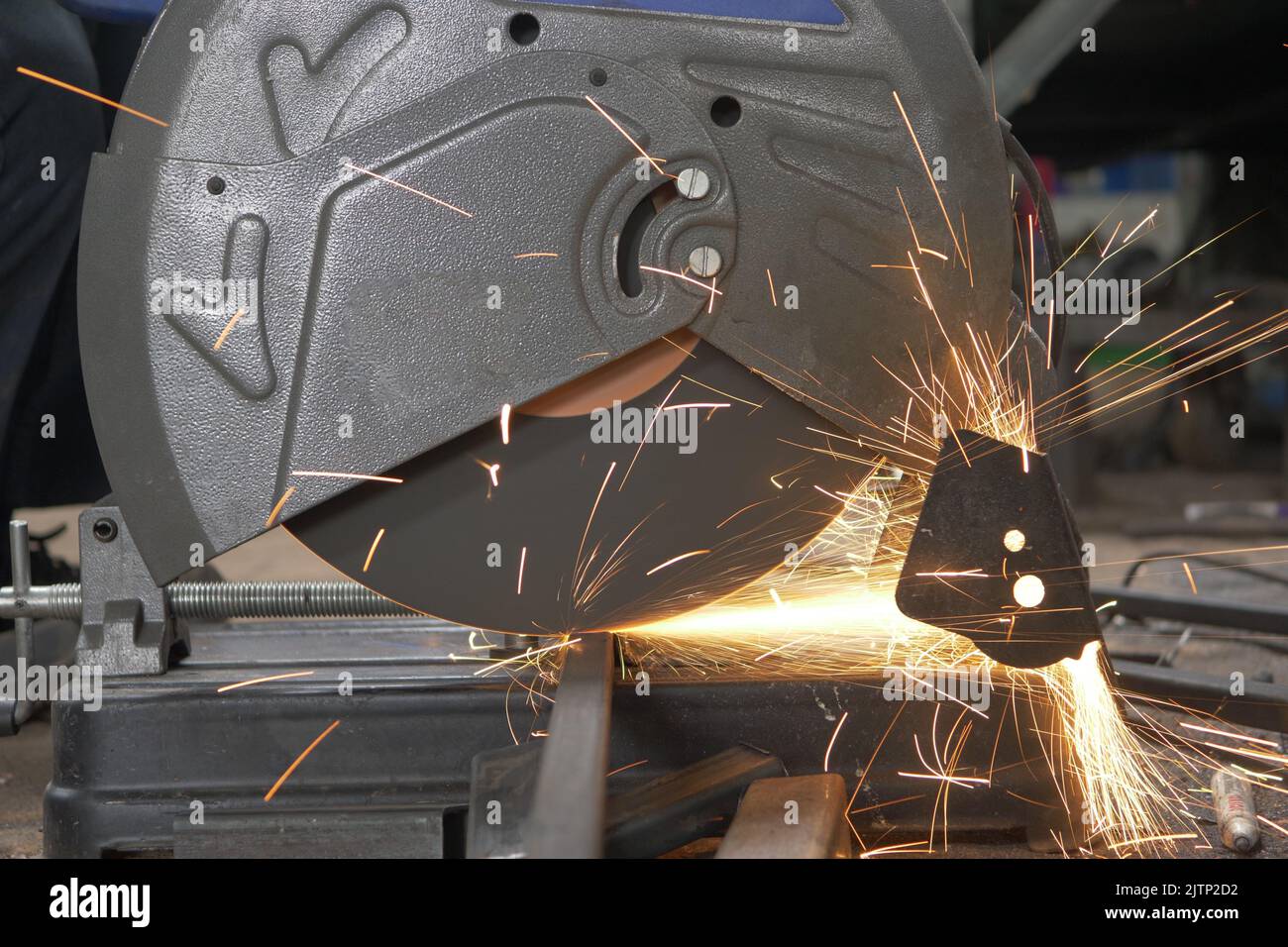 Worker cutting steel with cutting wheel saw, Sparks coming out of steel ...