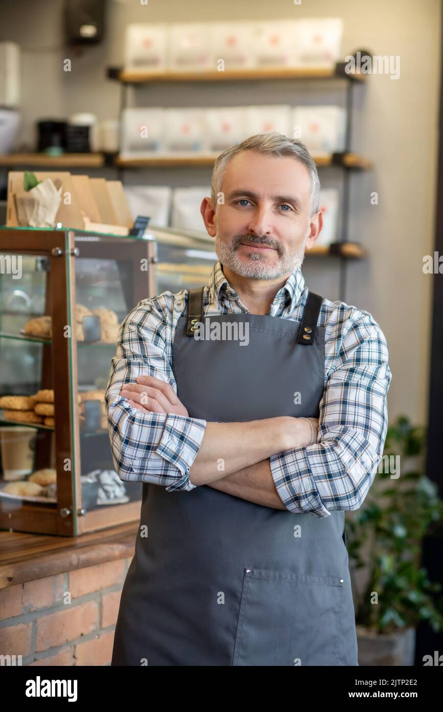 Pastry shop owner posing for the camera in his establishment Stock ...