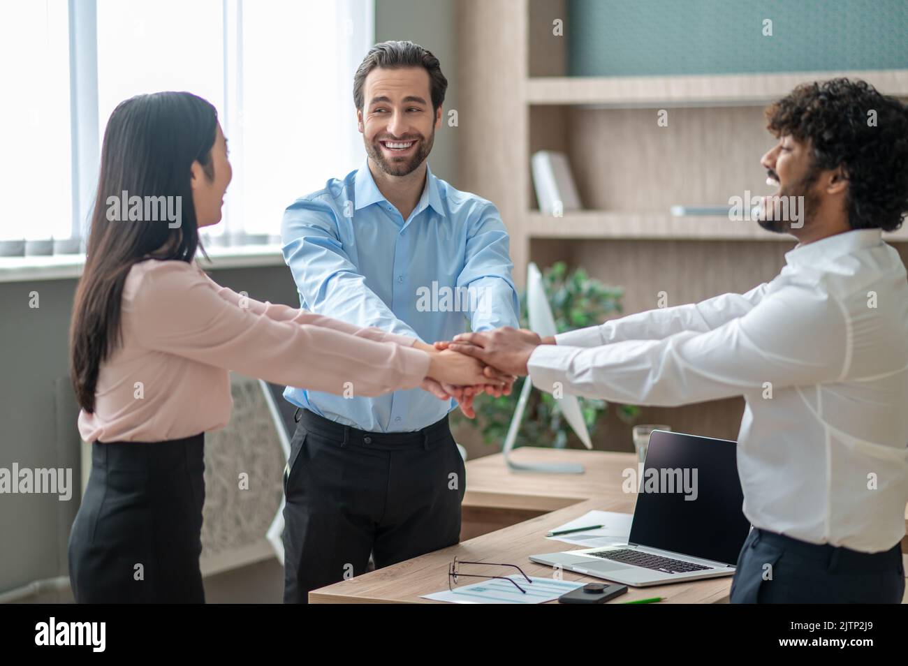 Young business people looking excited and happy Stock Photo - Alamy
