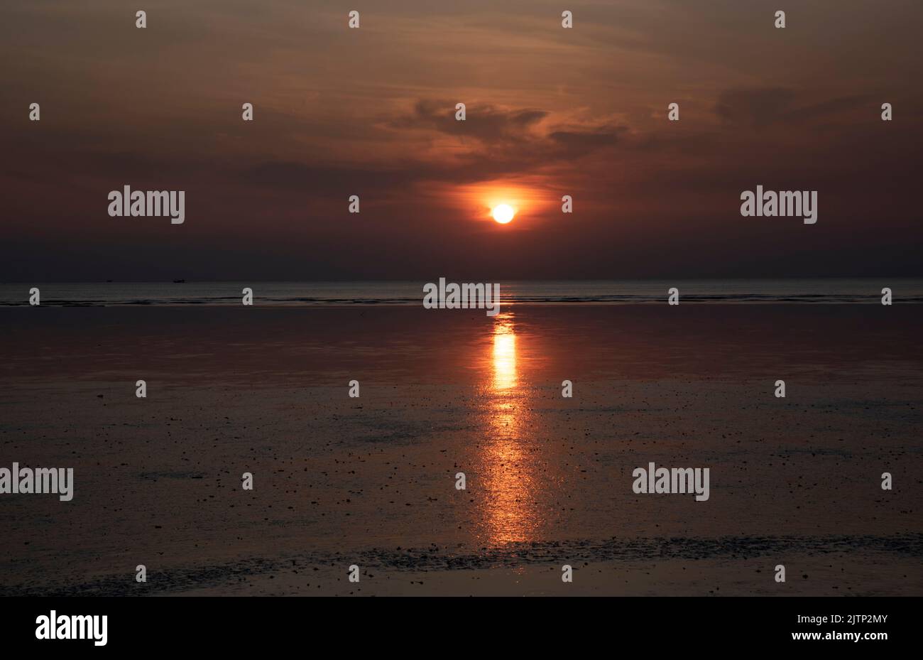 sunset during low-tide at the beach Stock Photo - Alamy