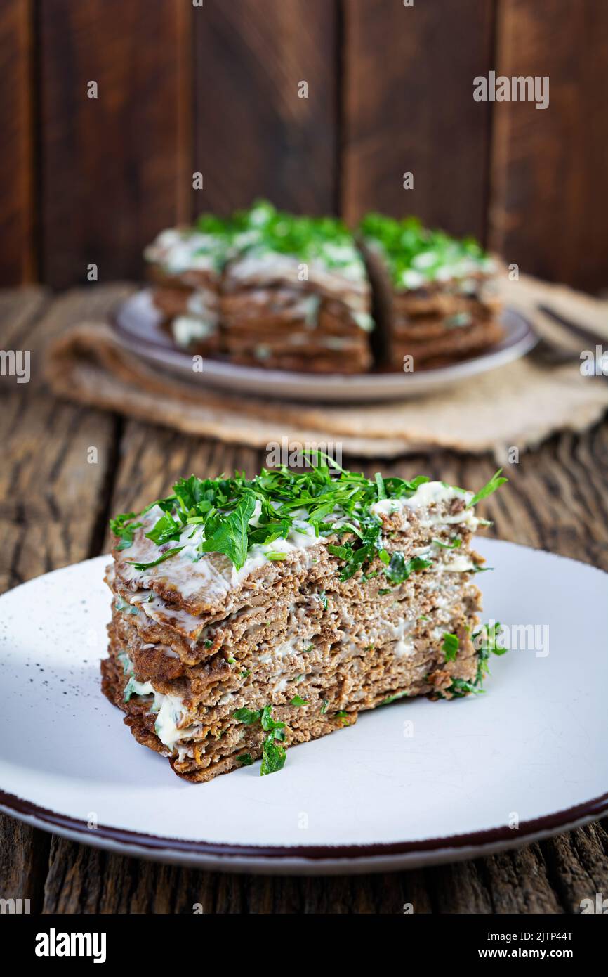 Liver cake on wooden background. Sliced layered liver cake with ...