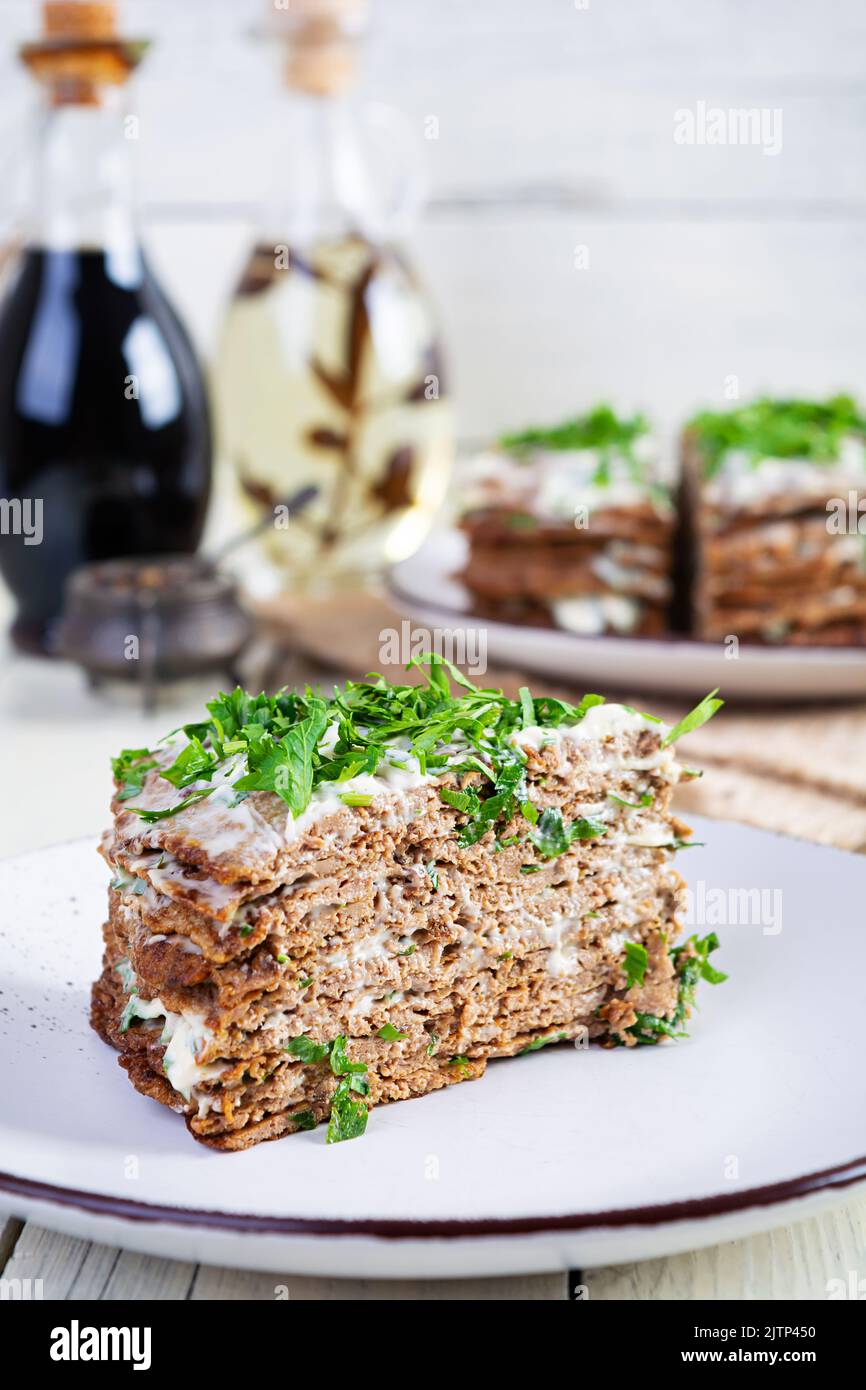 Liver cake on wooden background. Sliced layered liver cake with ...