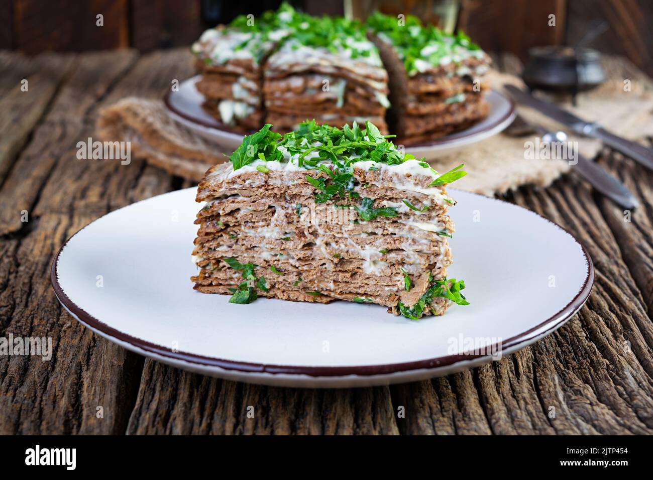 Liver cake on wooden background. Sliced layered liver cake with ...