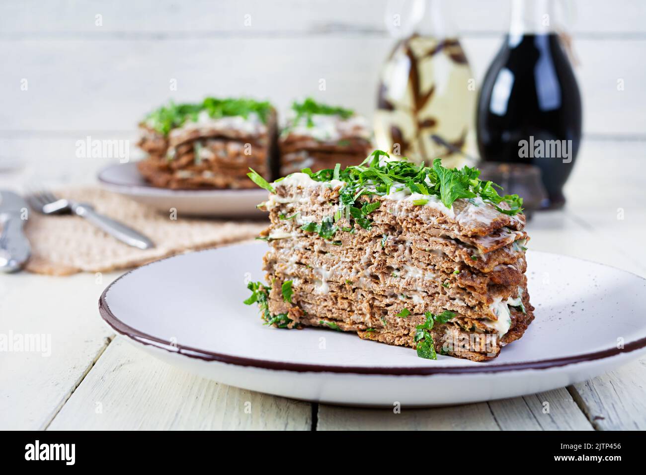 Liver cake on wooden background. Sliced layered liver cake with ...