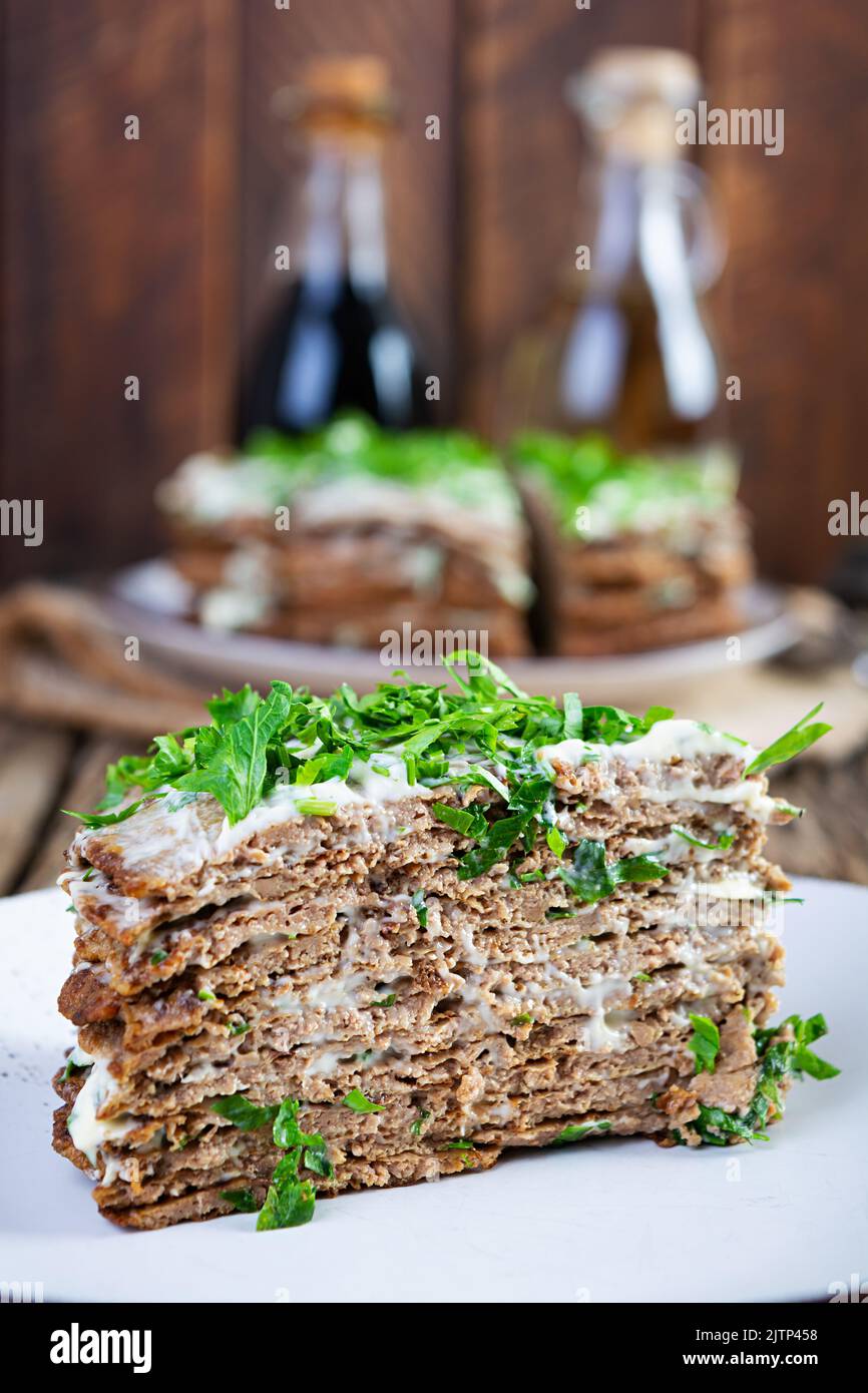 Liver cake on wooden background. Sliced layered liver cake with ...