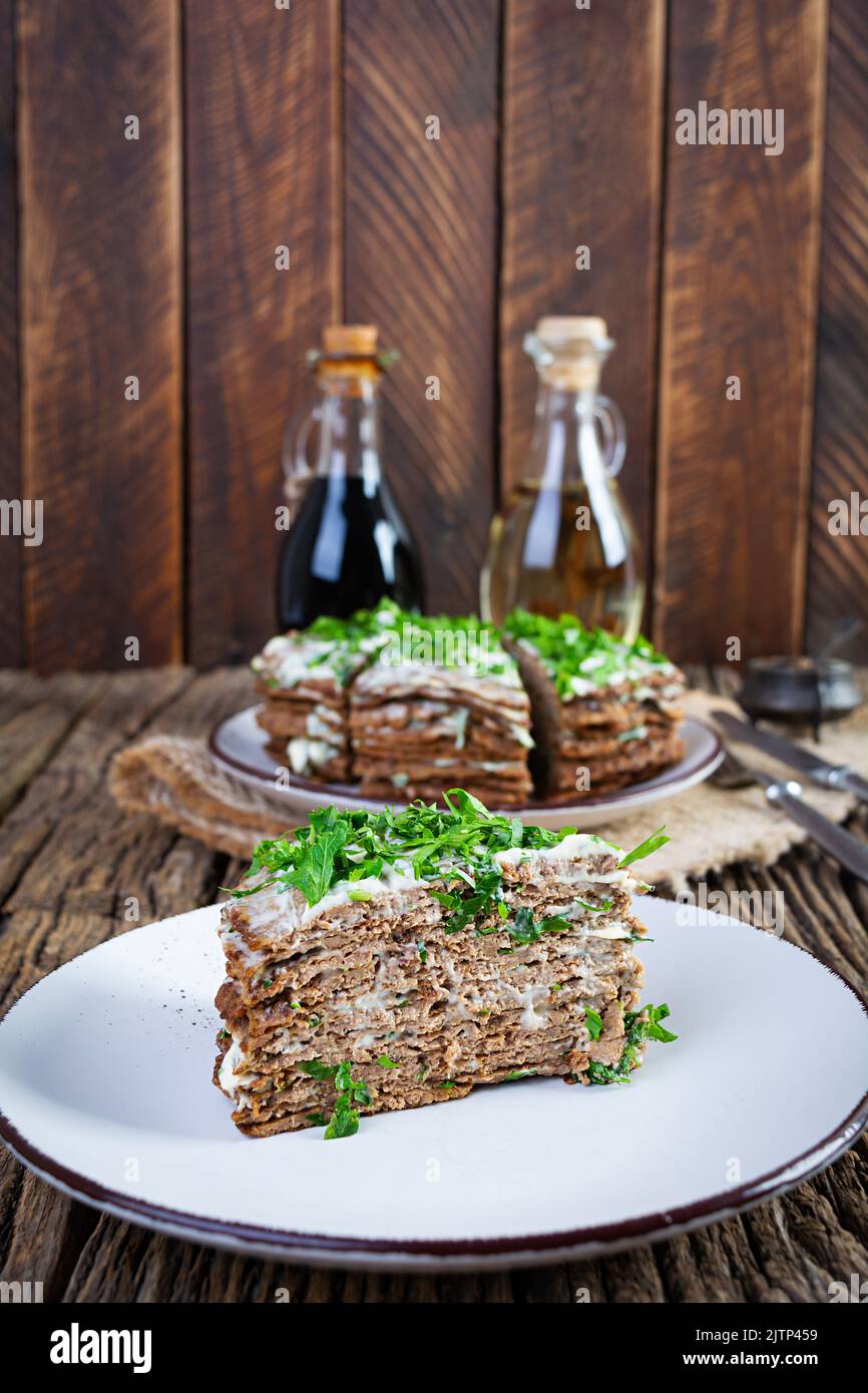 Liver cake on wooden background. Sliced layered liver cake with ...