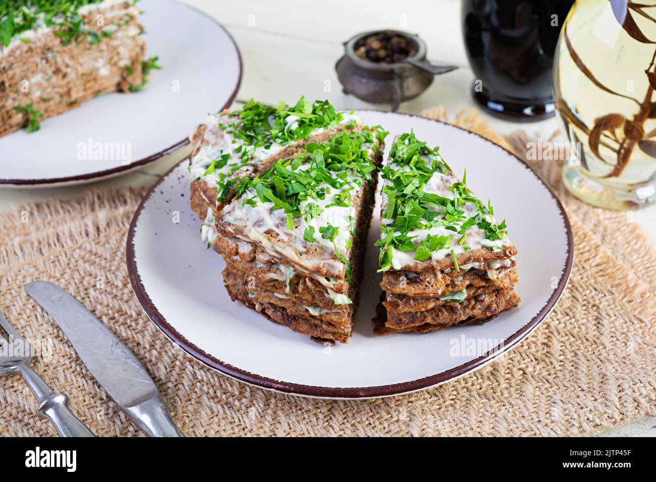 Liver cake on wooden background. Sliced layered liver cake with ...