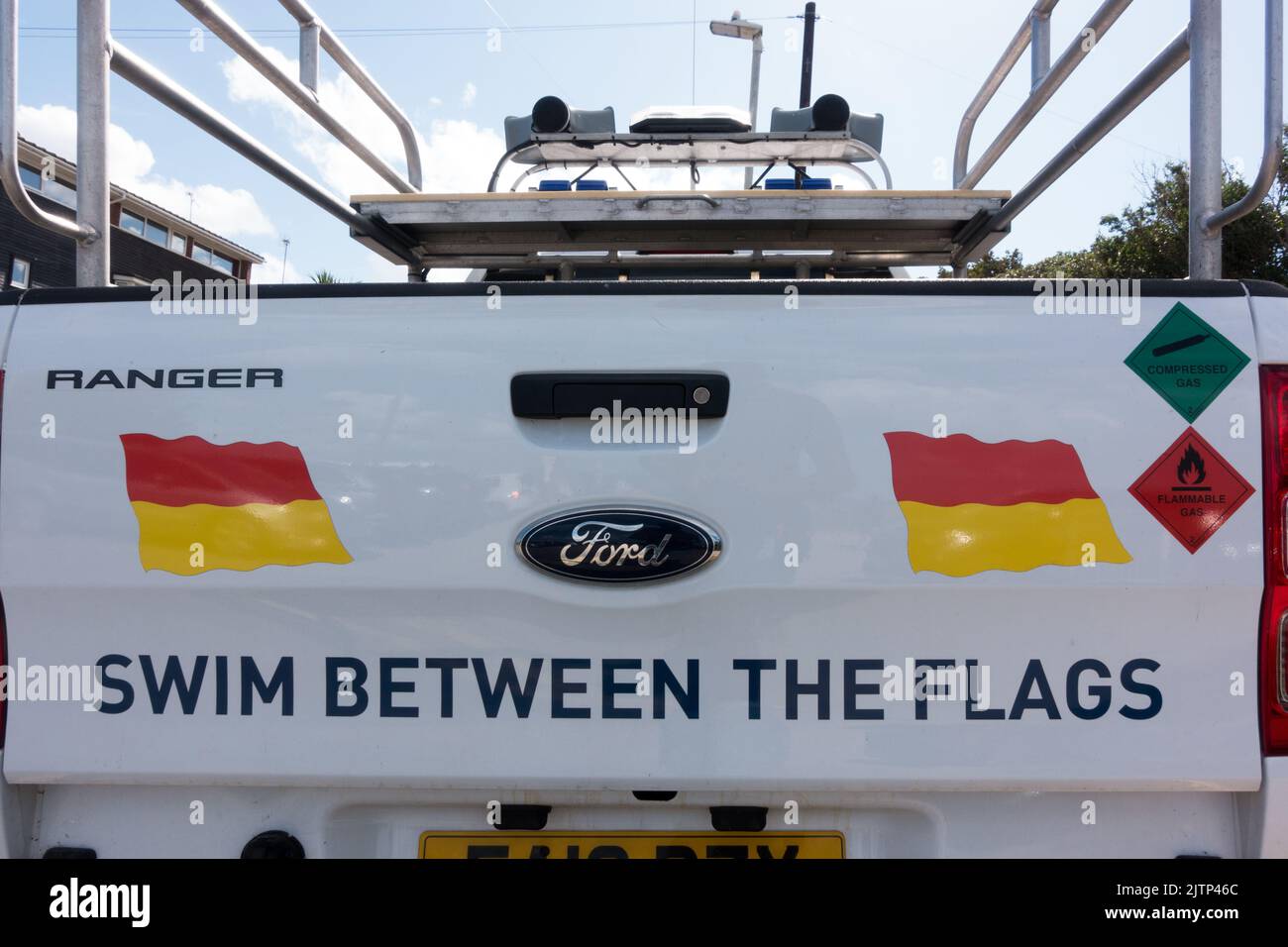 Swim Between the flags slogan on back of a RNLI (Royal National ...