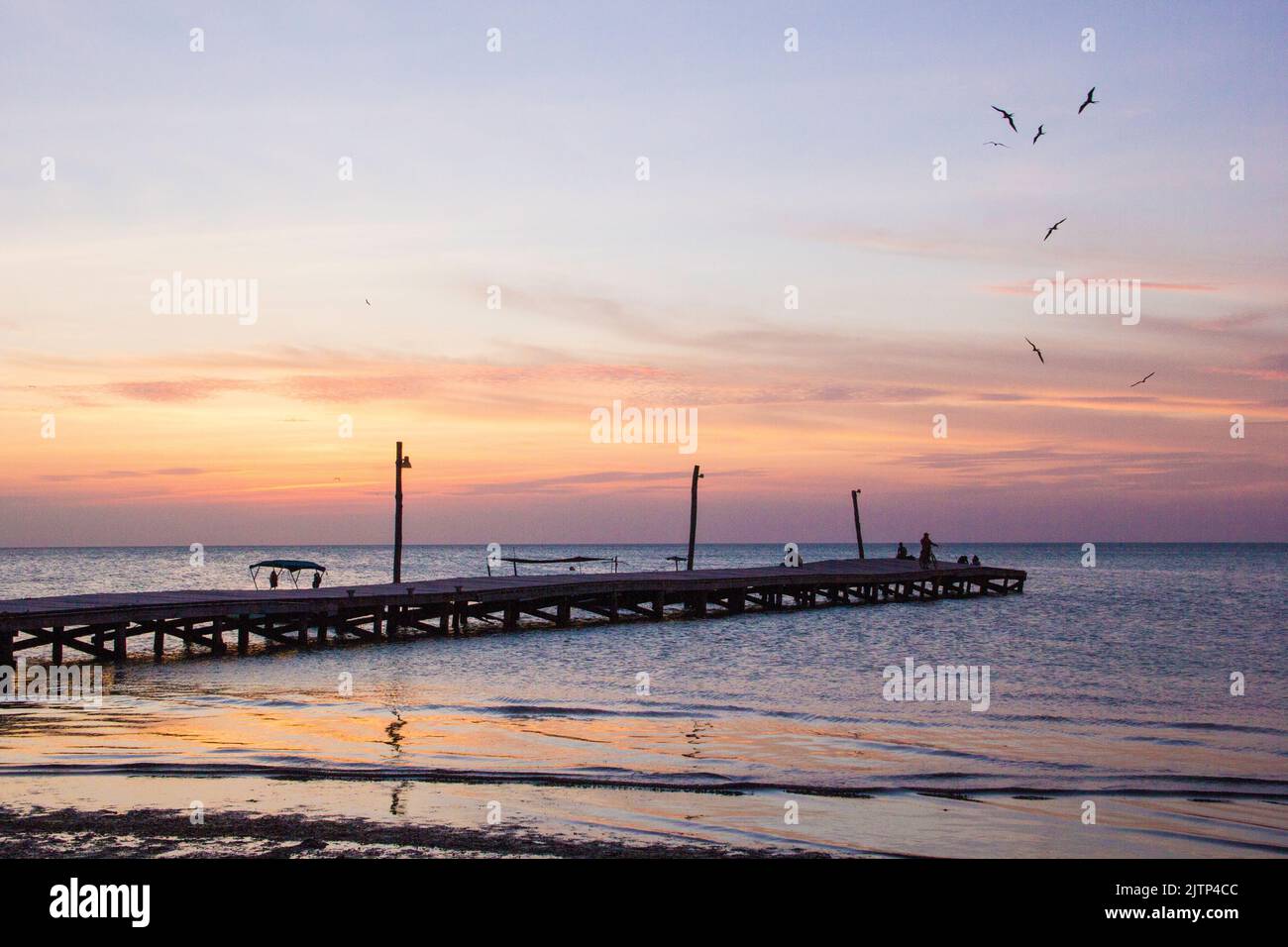 Sunset at the docks in Holbox, Mexico Stock Photo - Alamy