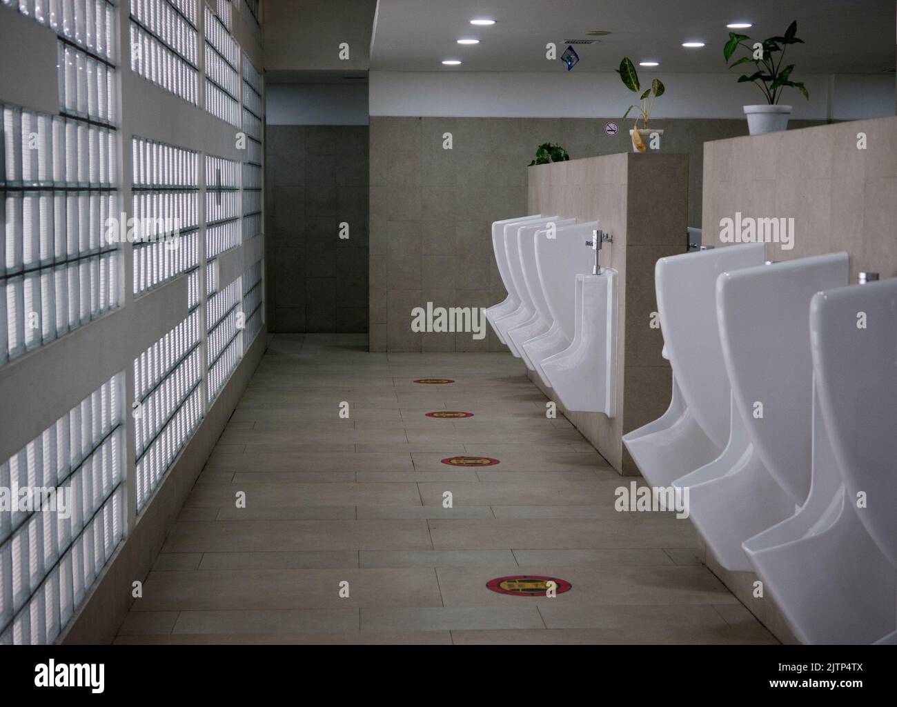 Interior design of standing toilet row Stock Photo - Alamy