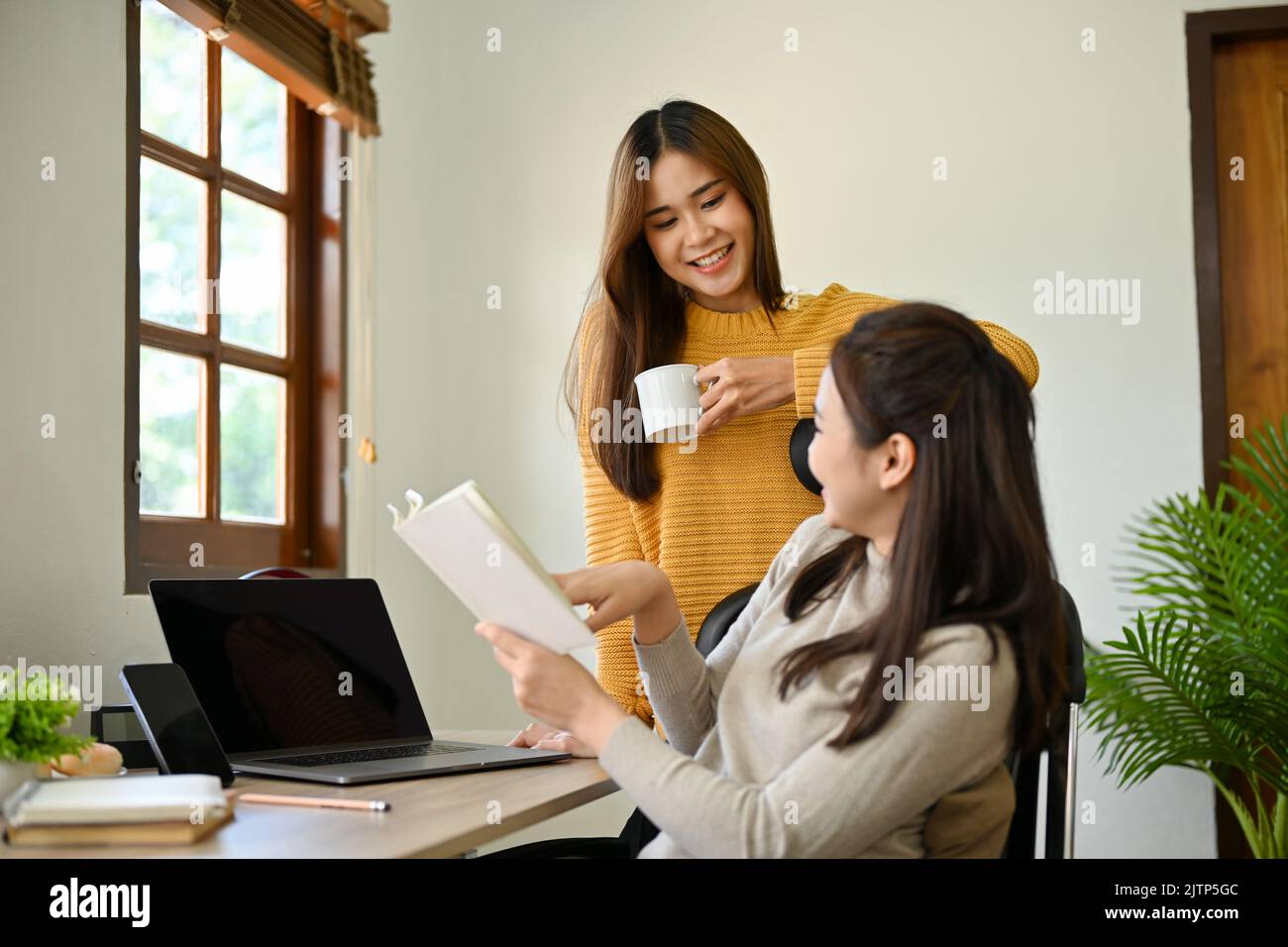 Two attractive young Asian female college students happy to do a ...