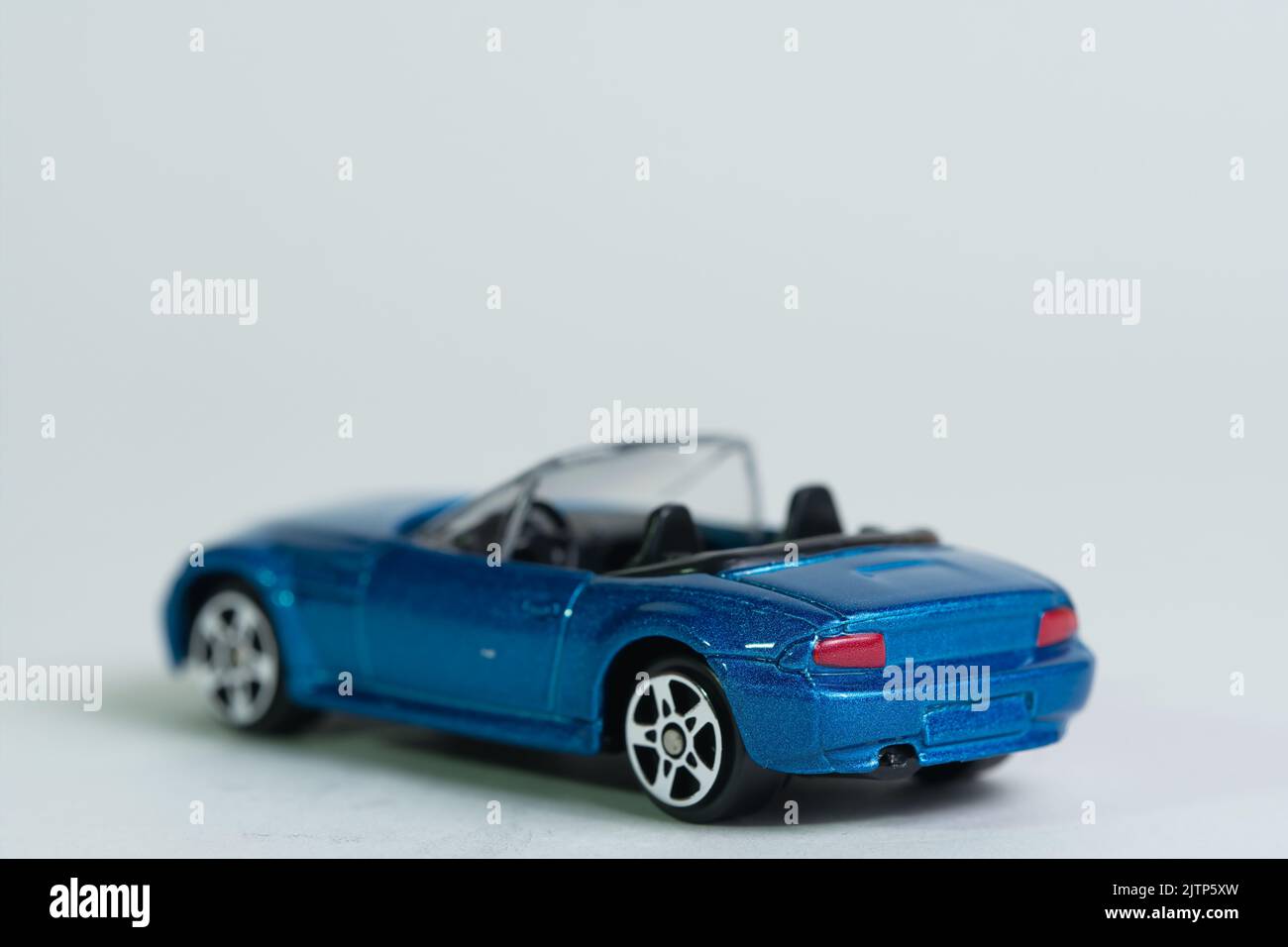 blue cabriolet sports car, toy car, white background, rear view Stock ...
