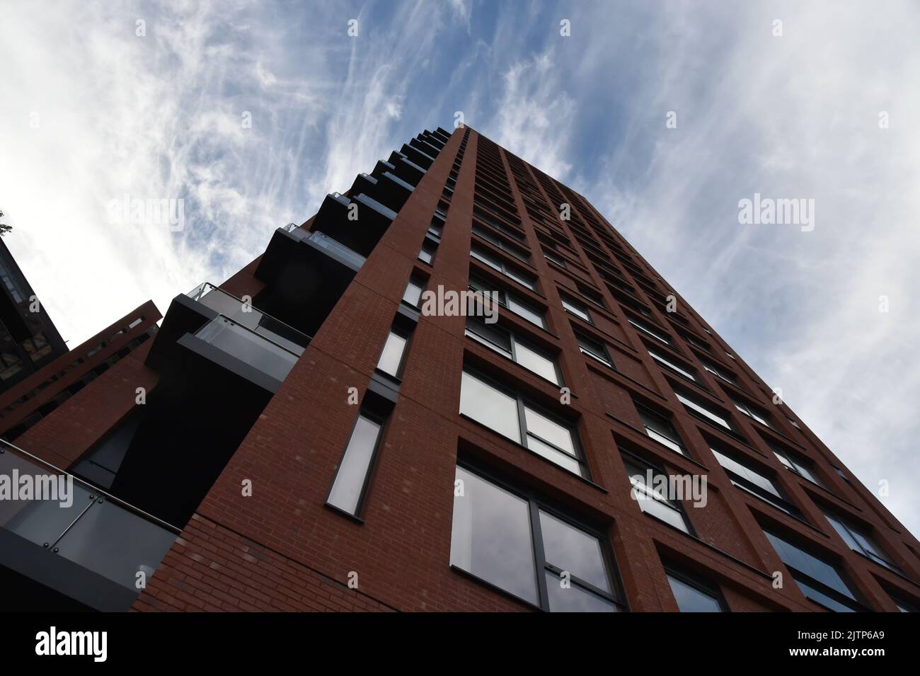 Looking up at Red Brick high rise apartment tower in east london Stock ...