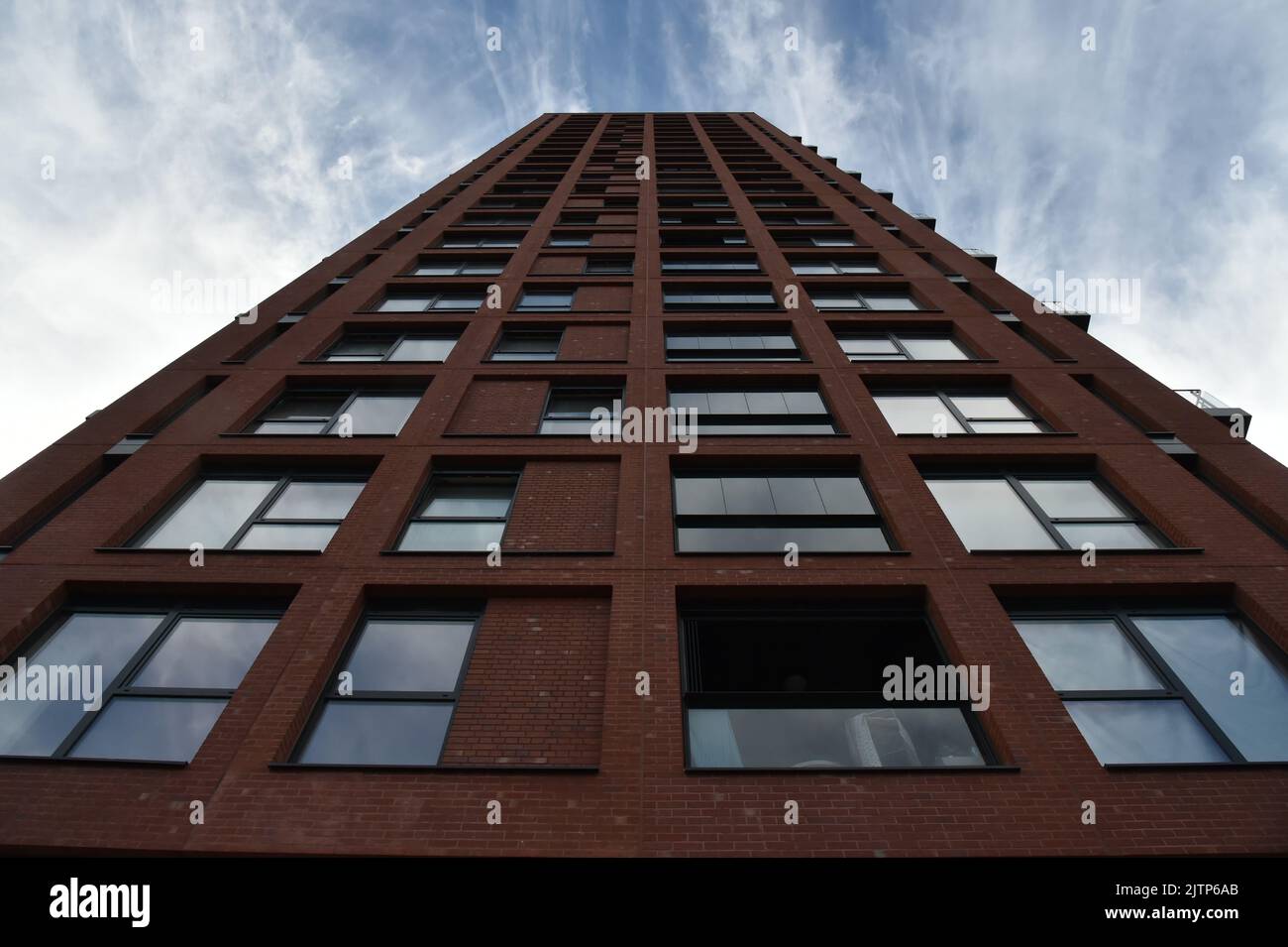 Looking up at Red Brick high rise apartment tower in east london Stock ...