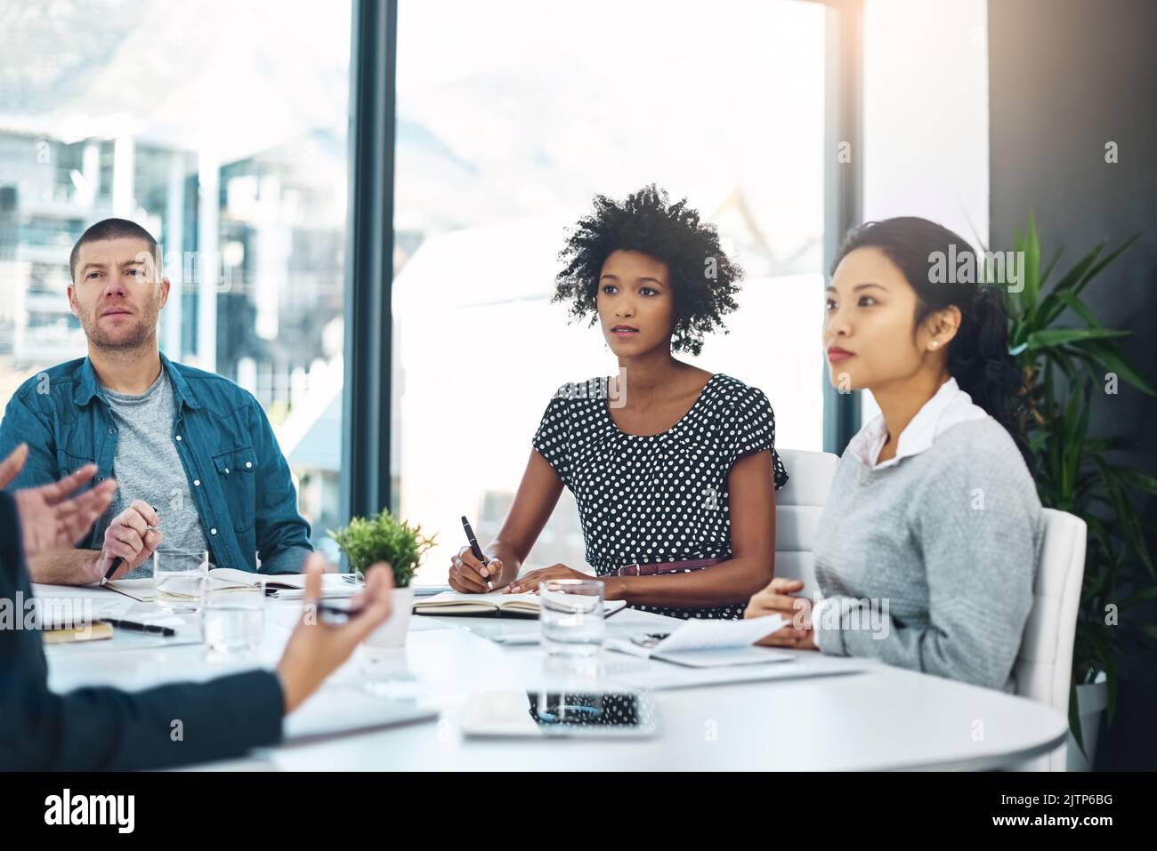 Intrigued by new business ideas. a group of coworkers talking together ...