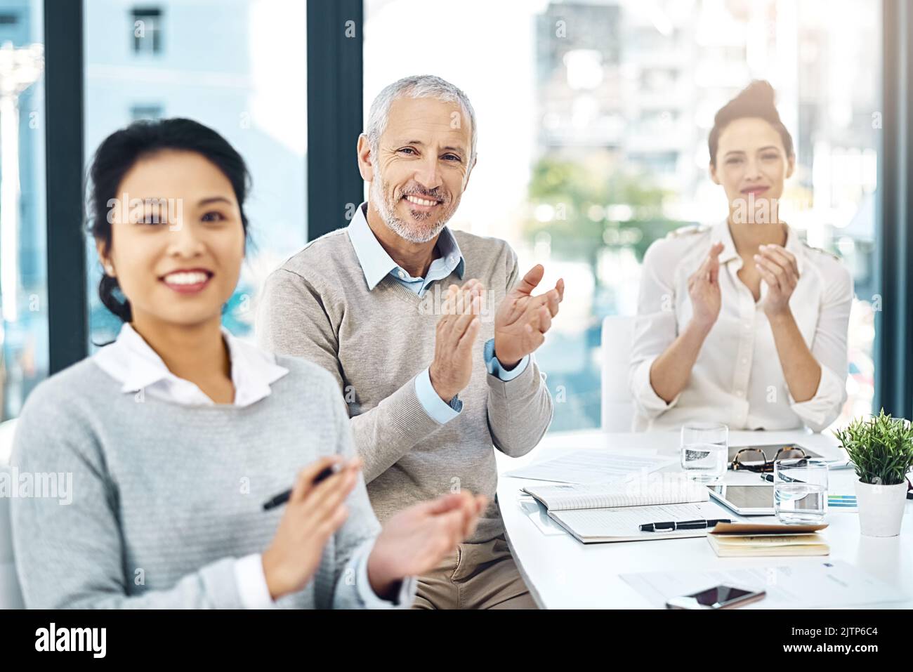 Amazing presentation. Portrait of a group of colleagues clapping while ...