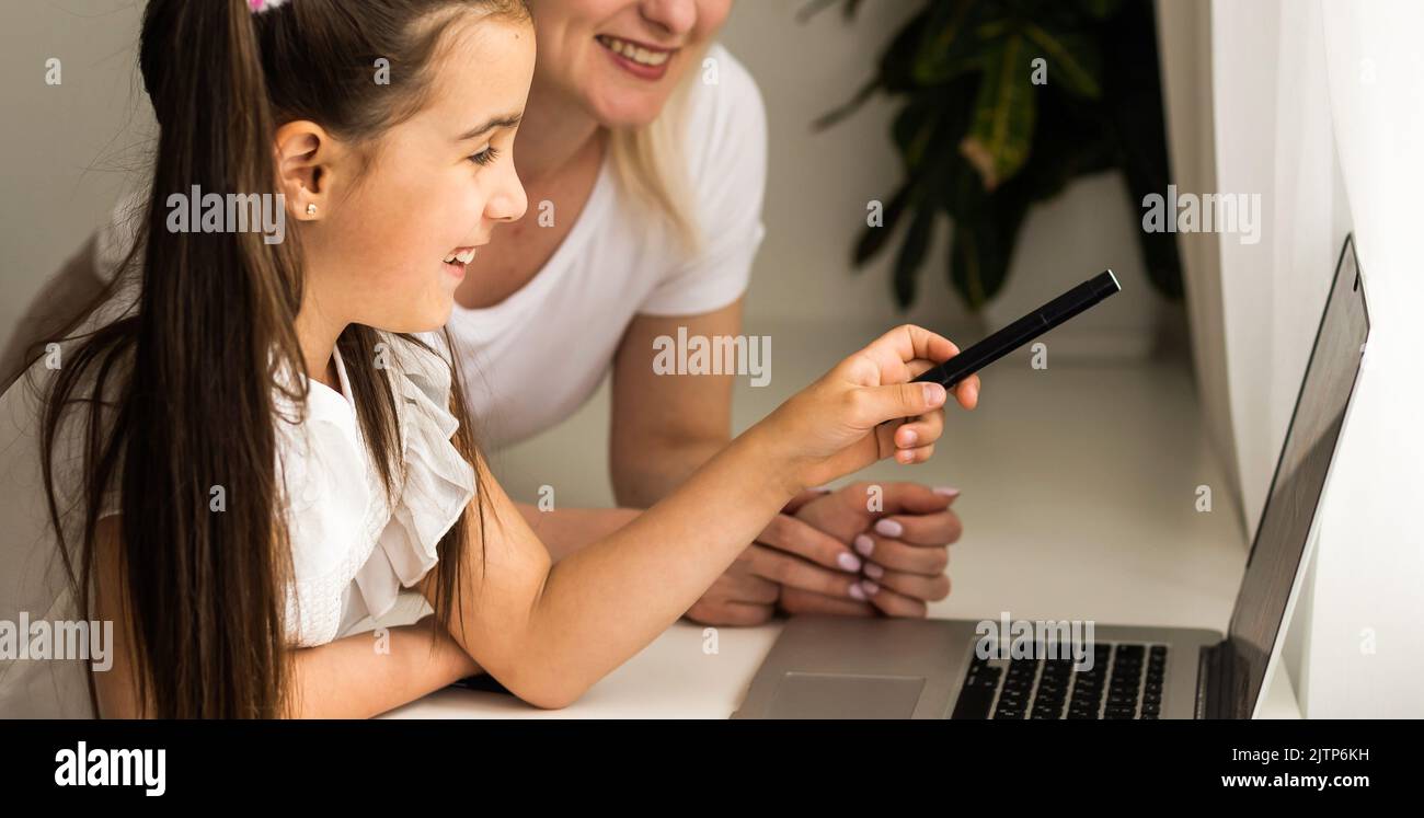 Homeschool little young girl learning online class from school teacher ...