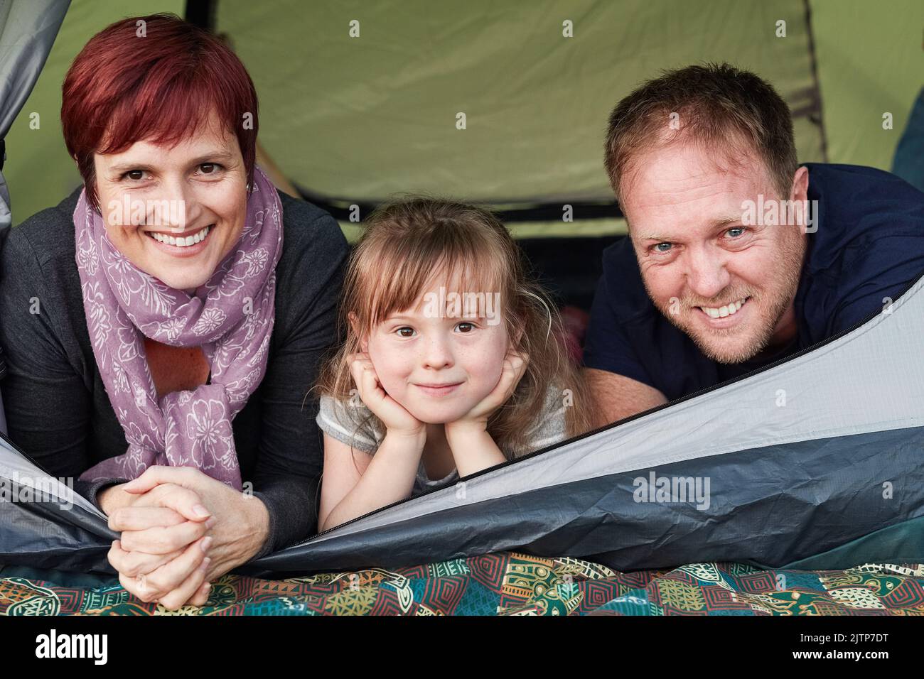 Come in, its cosy in here. Portrait of a cute little girl and her ...