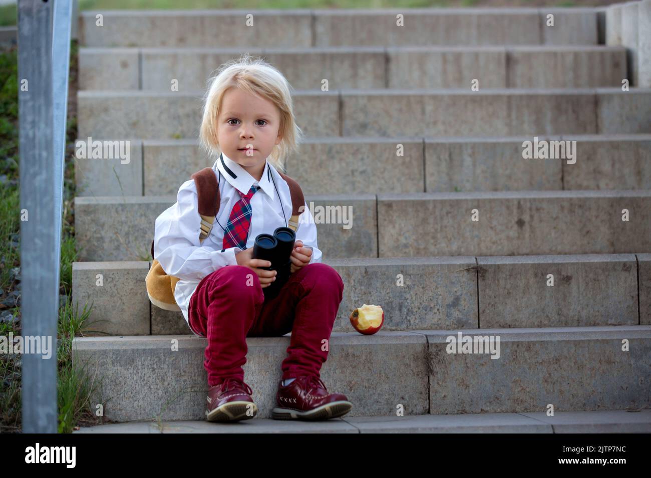 Preschool blond child, cute boy in uniform, holding apple, going in ...