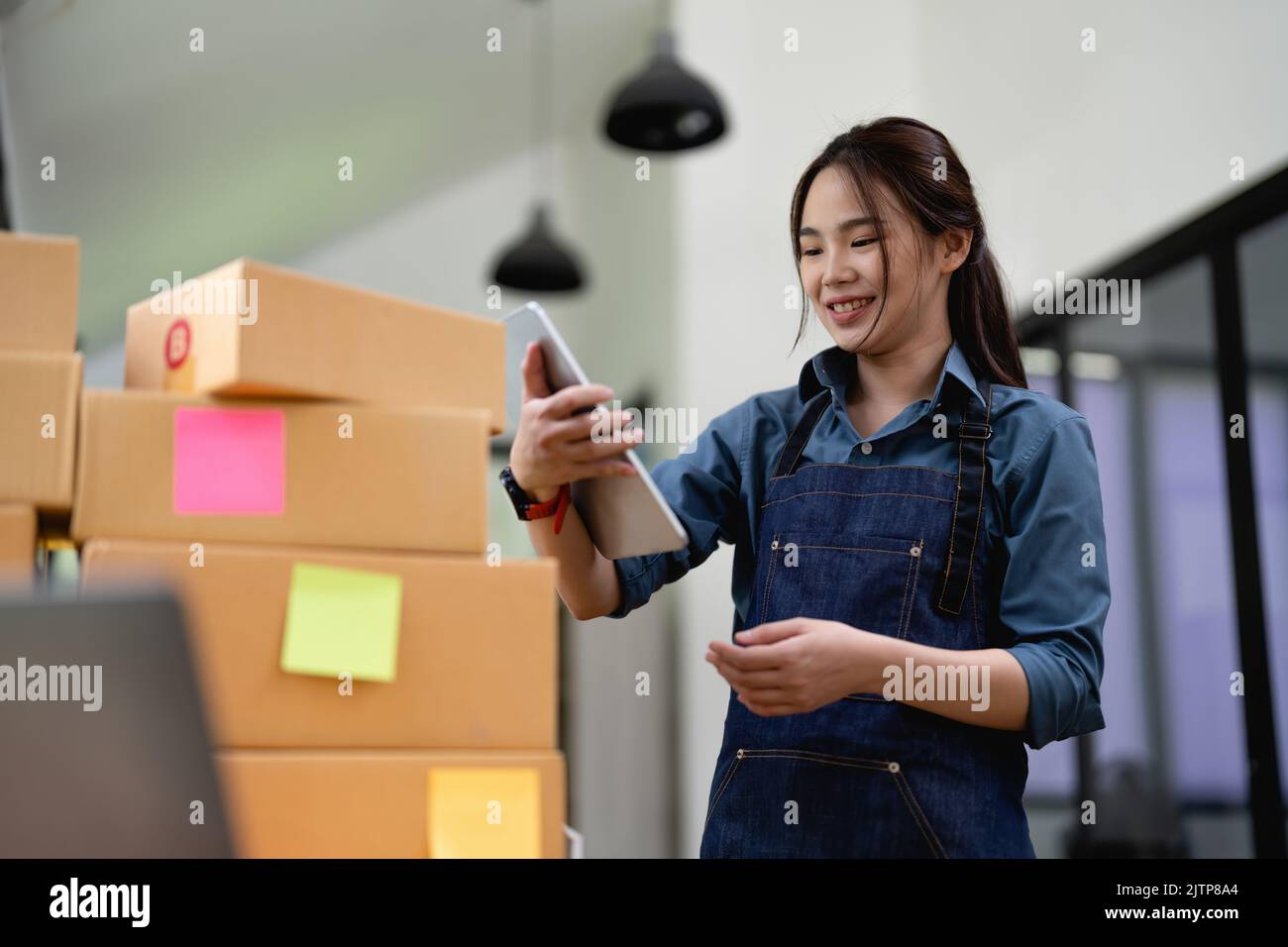 Young attractive asian woman owner startup business with box at home ...