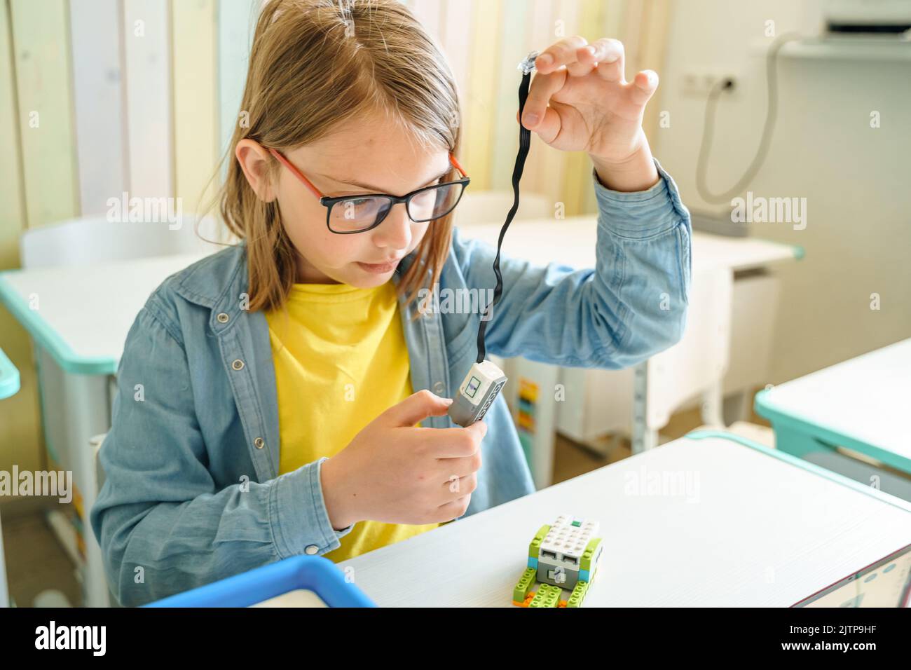 Programming work, learning robotics in elementary school. Children students assembly, launch ...