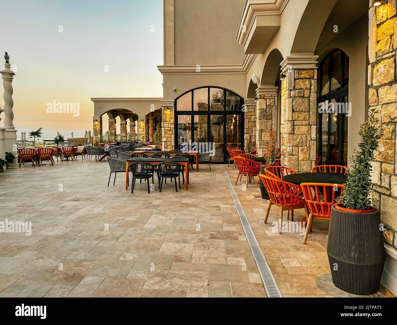 Deserted cafe of a tourist town. Cozy interior of a street restaurant ...
