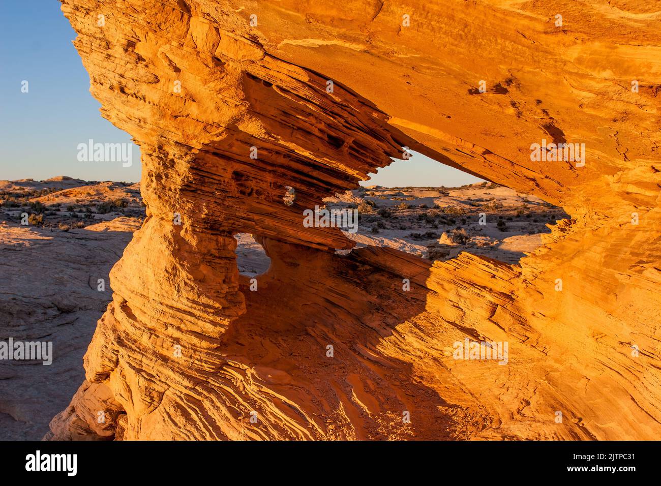 Multiple small arches in the colorful sandstone in the desert near Moab ...